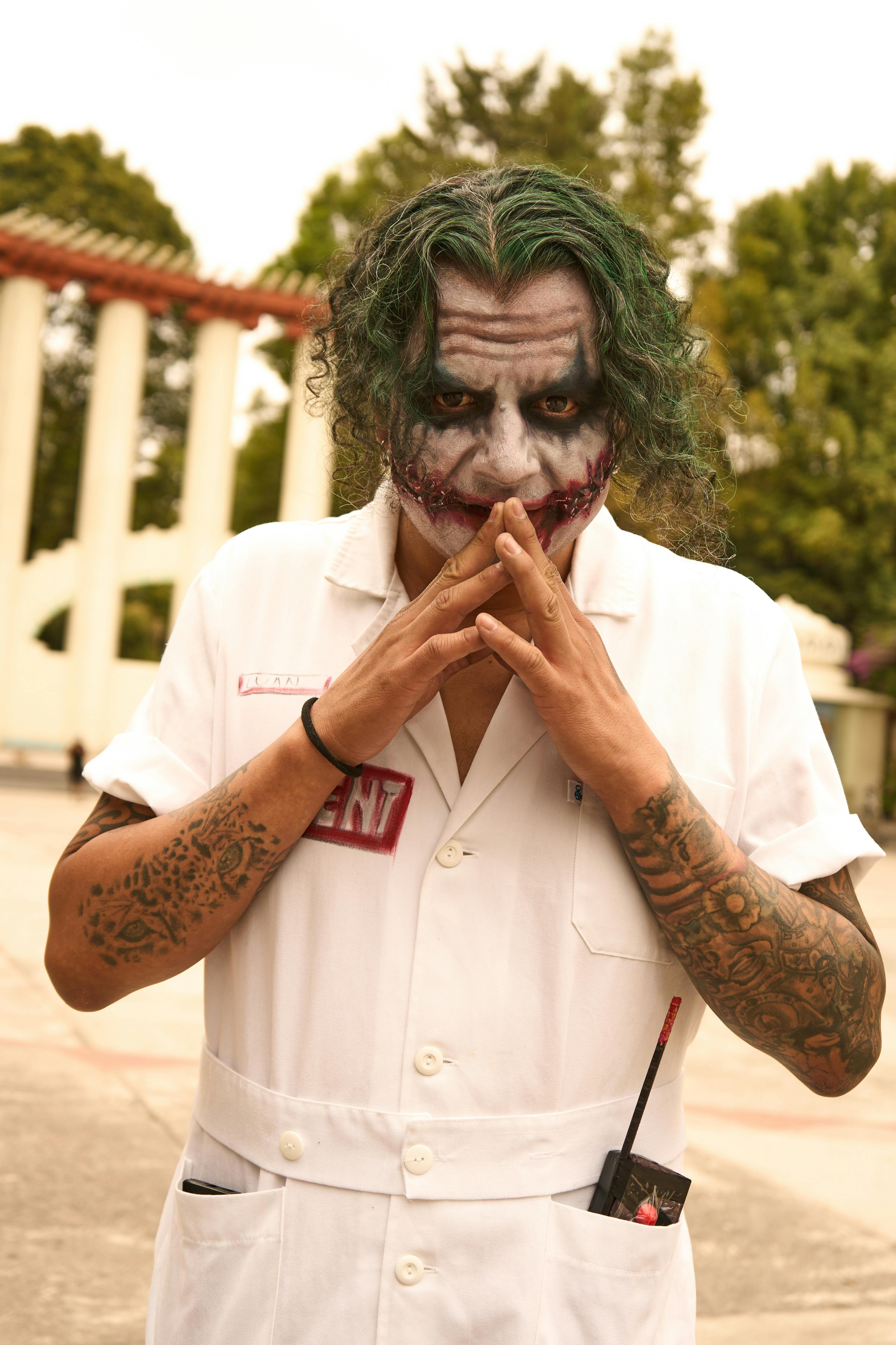 Cosplayer as Joker with Cigarette in Park · Free Stock Photo