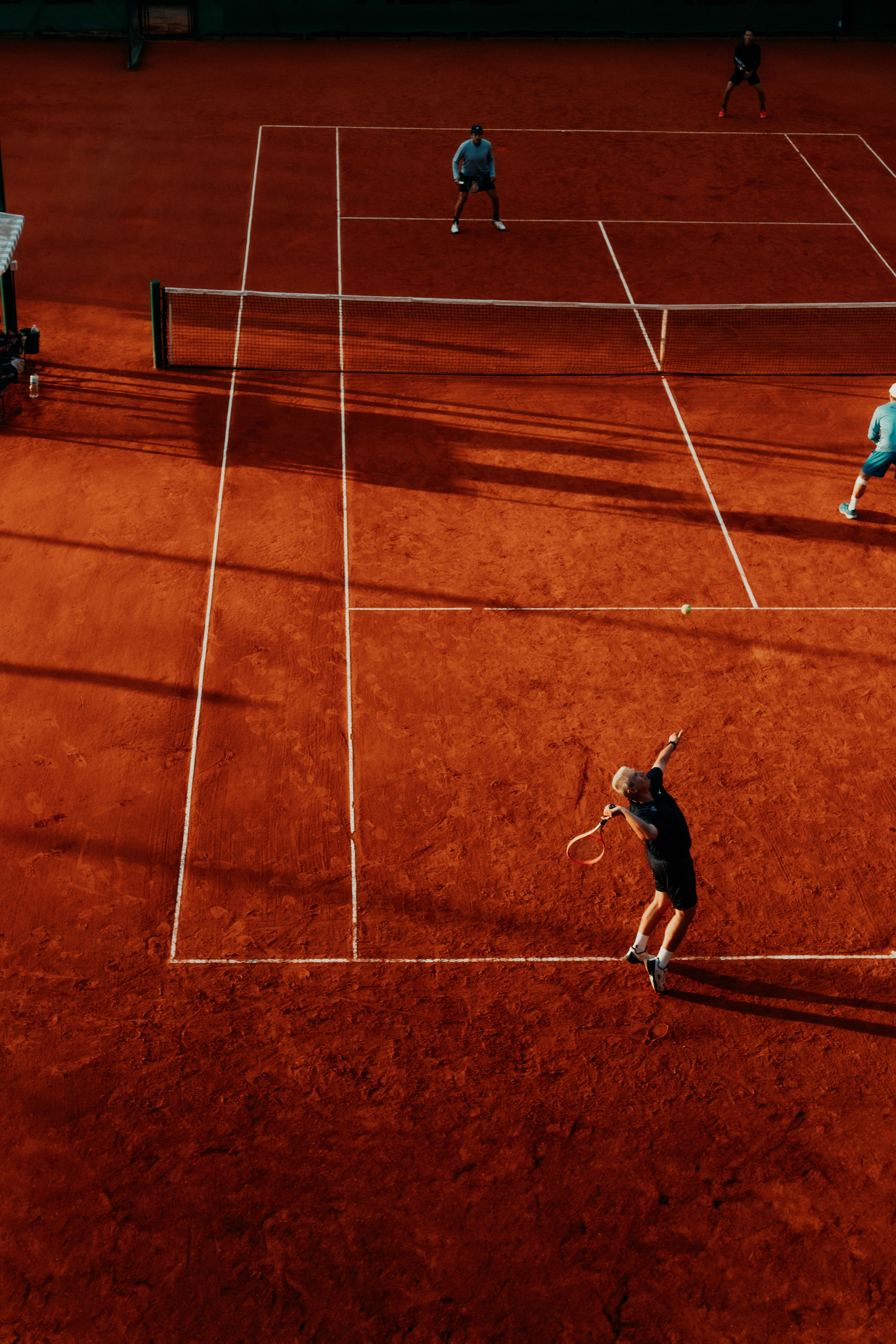 A Woman Playing Tennis on a Clay Court · Free Stock Photo