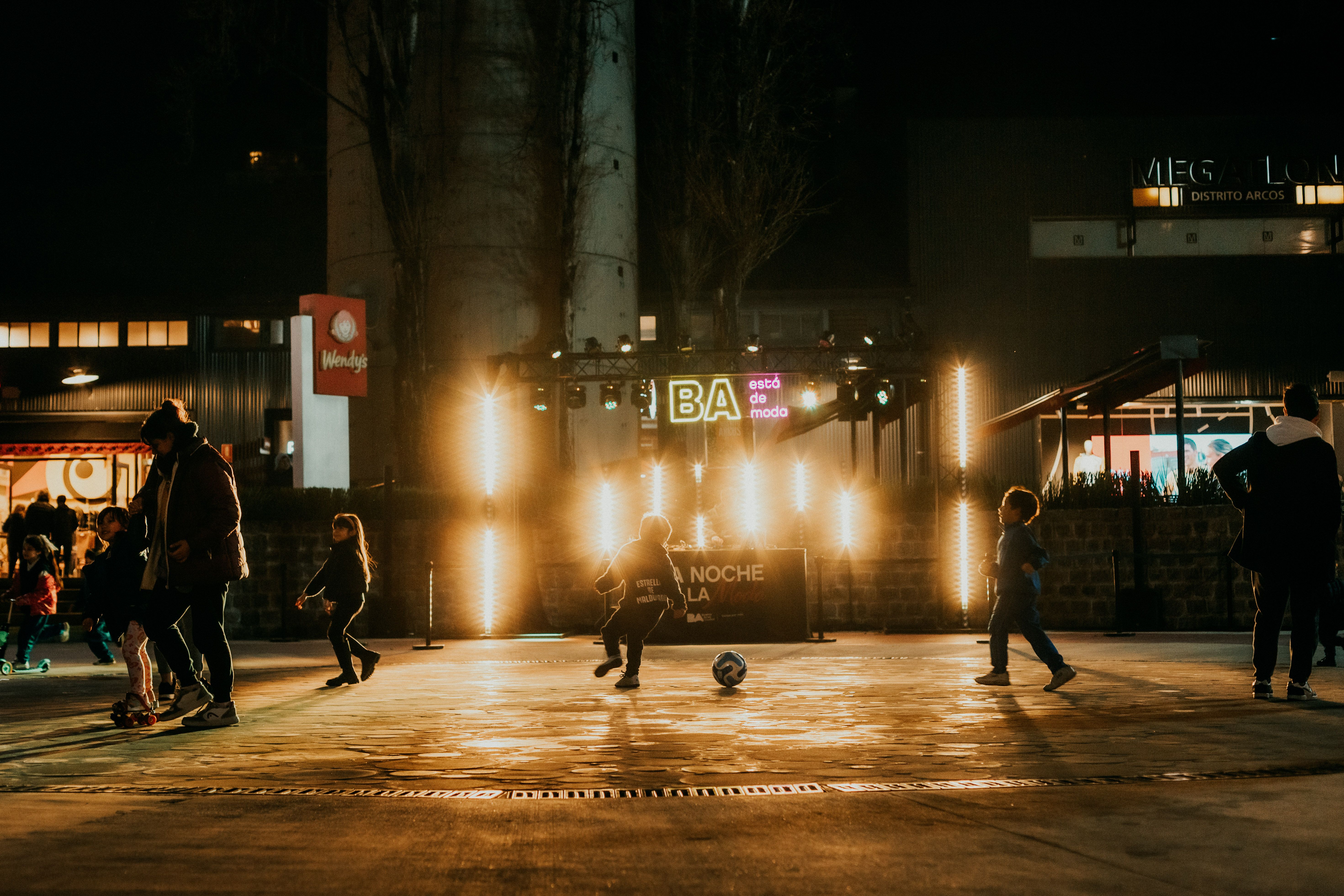 Children Playing Soccer at Night Event · Free Stock Photo
