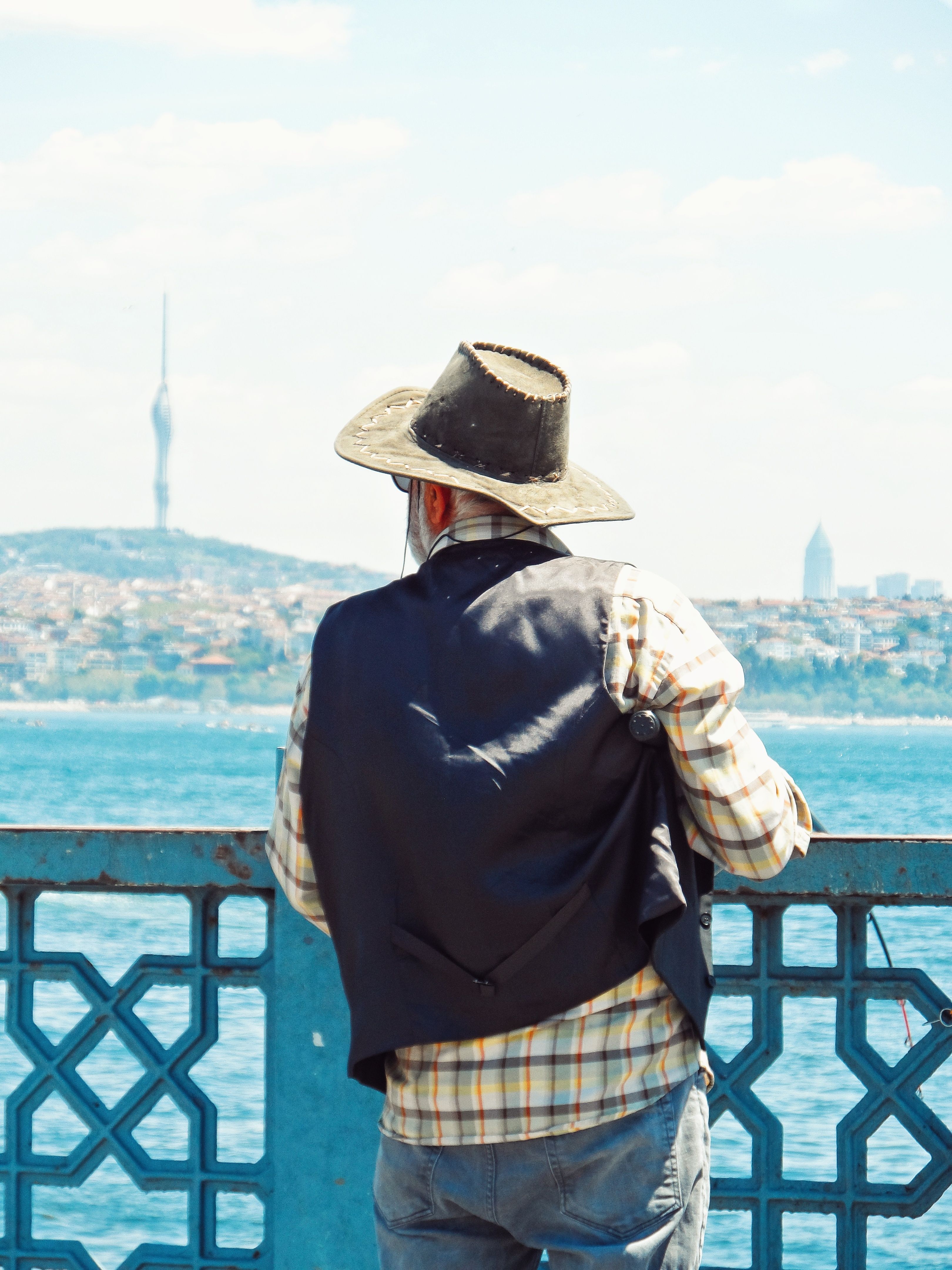 Man in Cowboy Hat Overlooking Bosphorus Sea · Free Stock Photo
