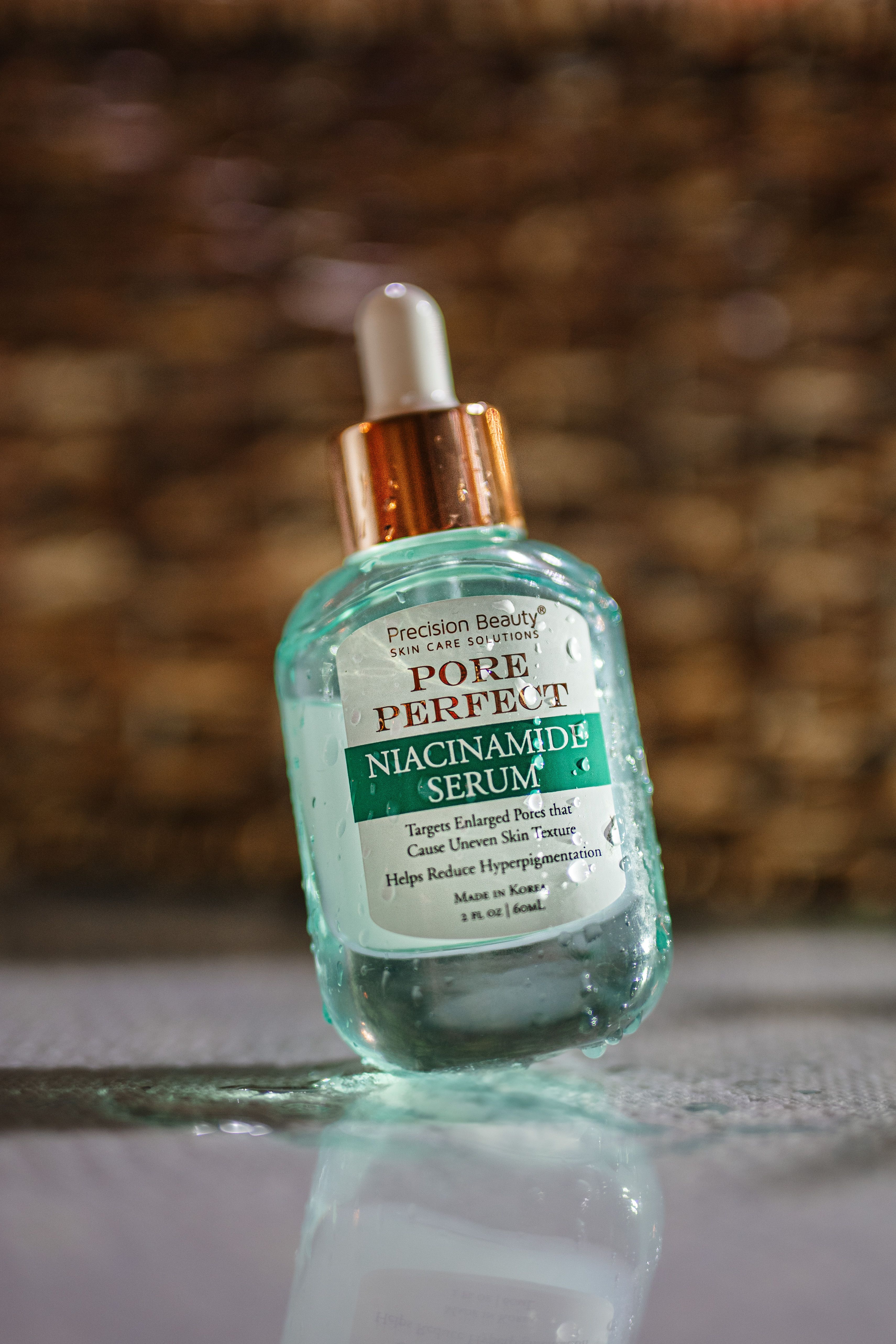 Pore Perfect Niacinamide Serum Bottle on Reflective Surface · Free ...