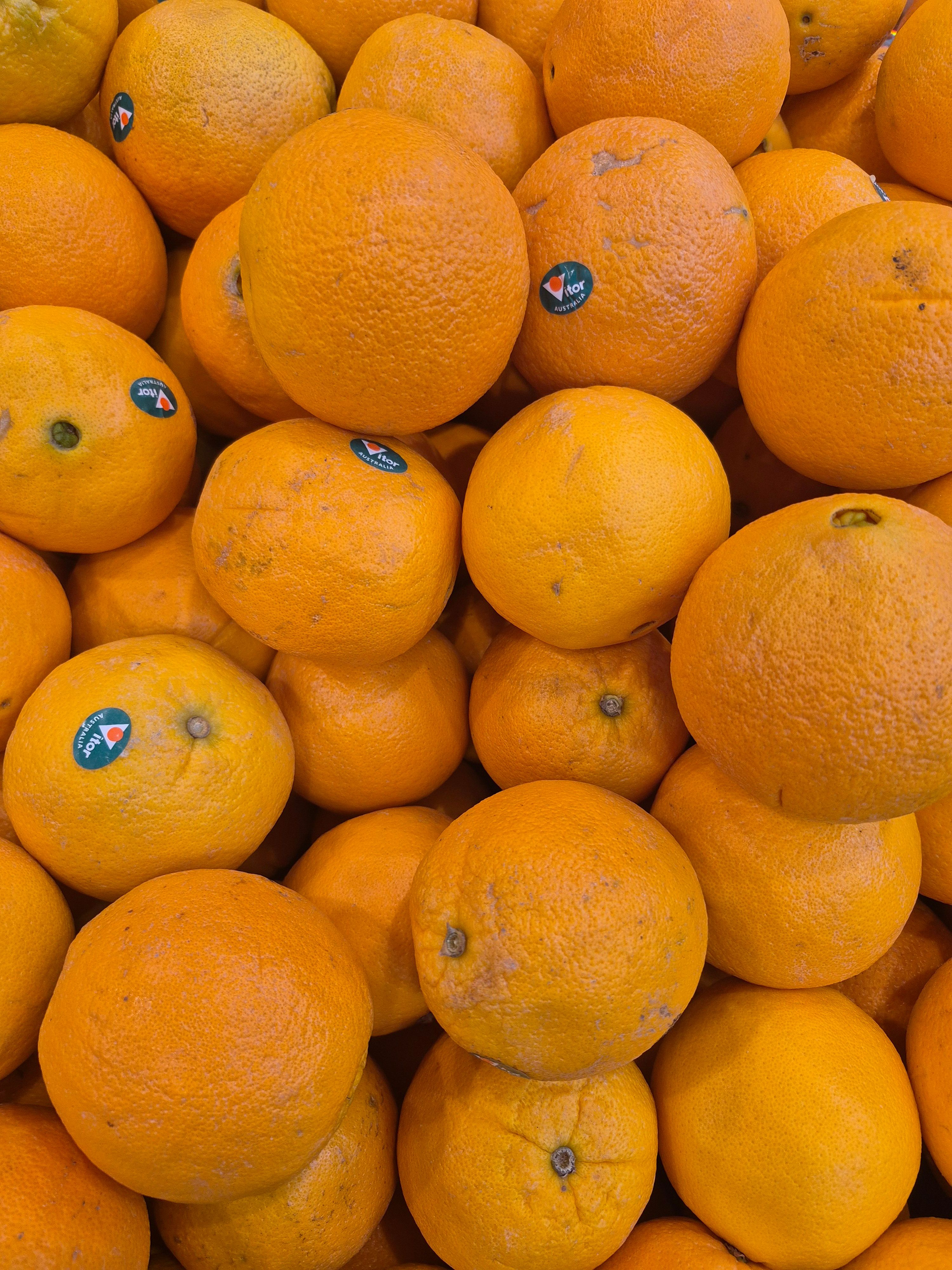 Fresh Oranges Stacked in Jakarta Market · Free Stock Photo