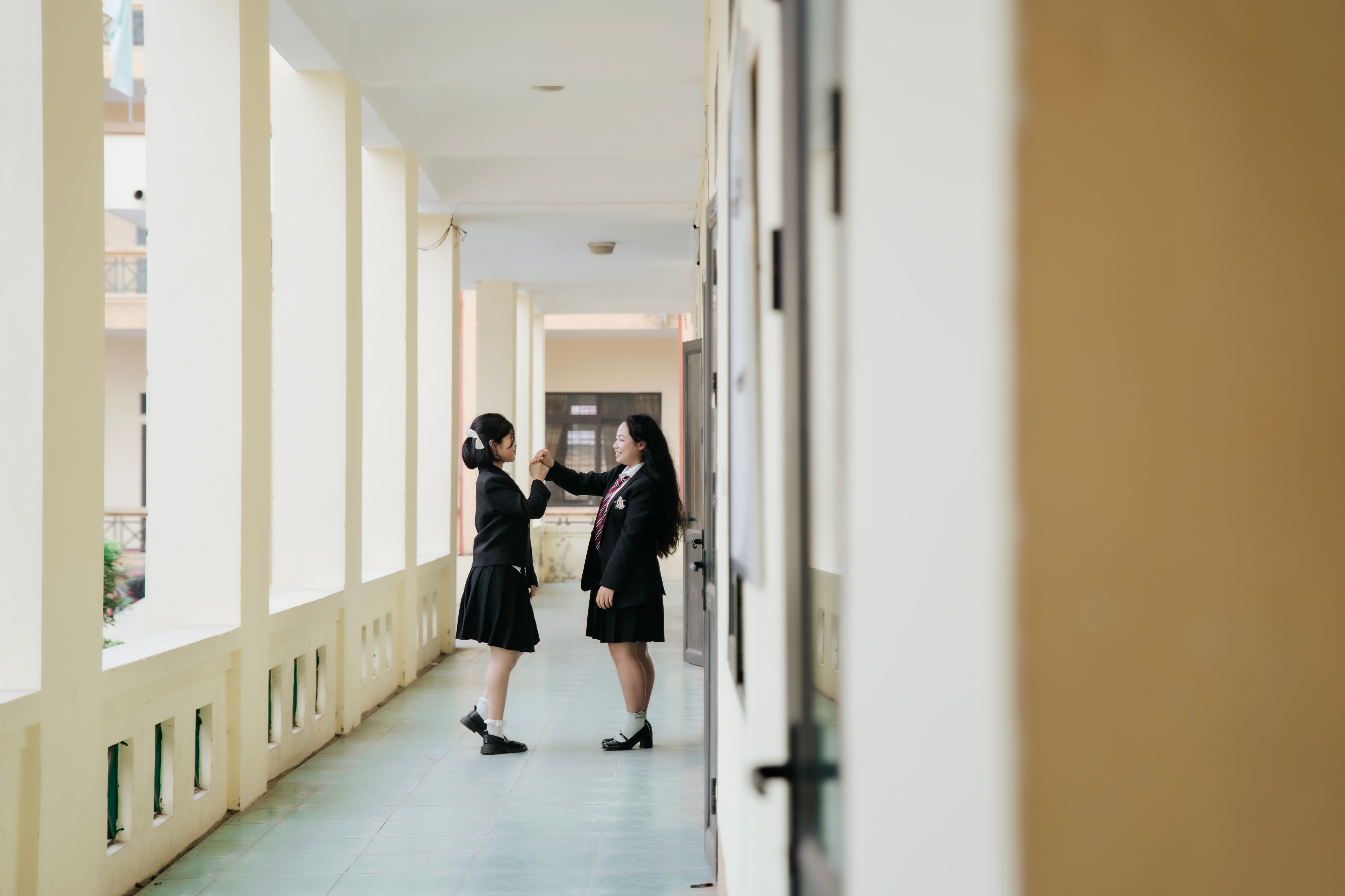 Students Conversing in School Corridor · Free Stock Photo