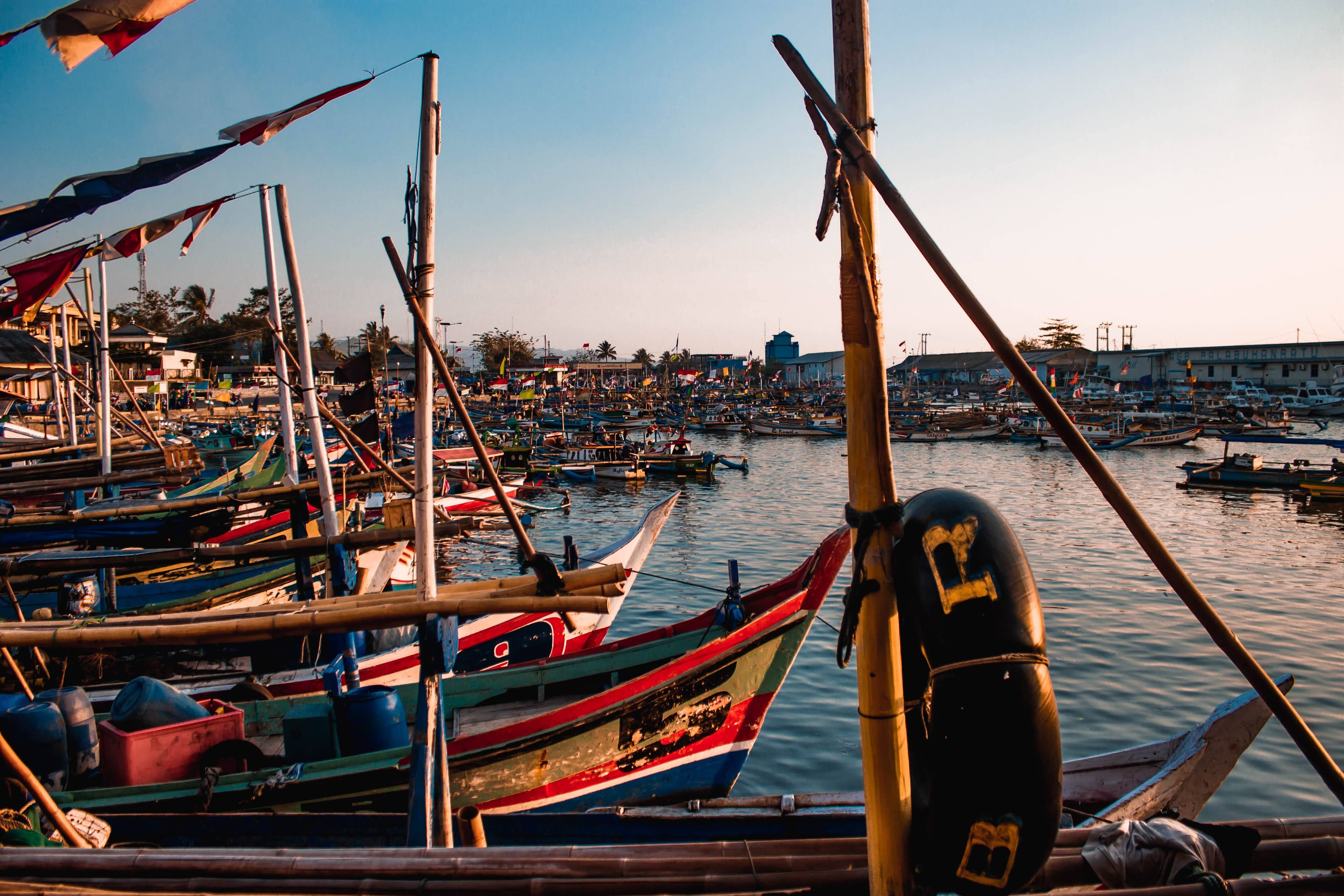 Colorful Fishing Boats at Sunrise in Asian Harbor · Free Stock Photo