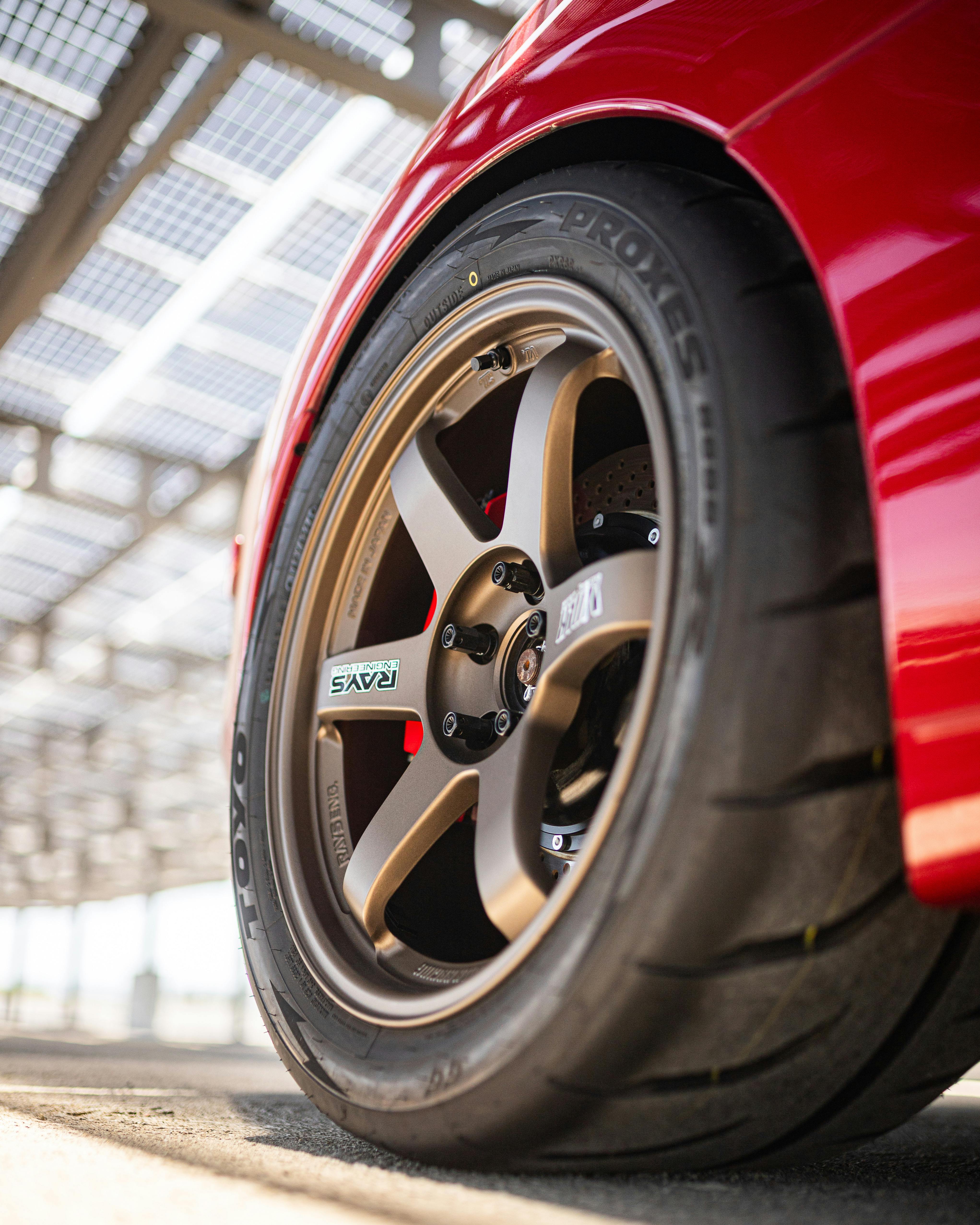Close-Up of Red Sports Car Wheel with Alloy Rims · Free Stock Photo