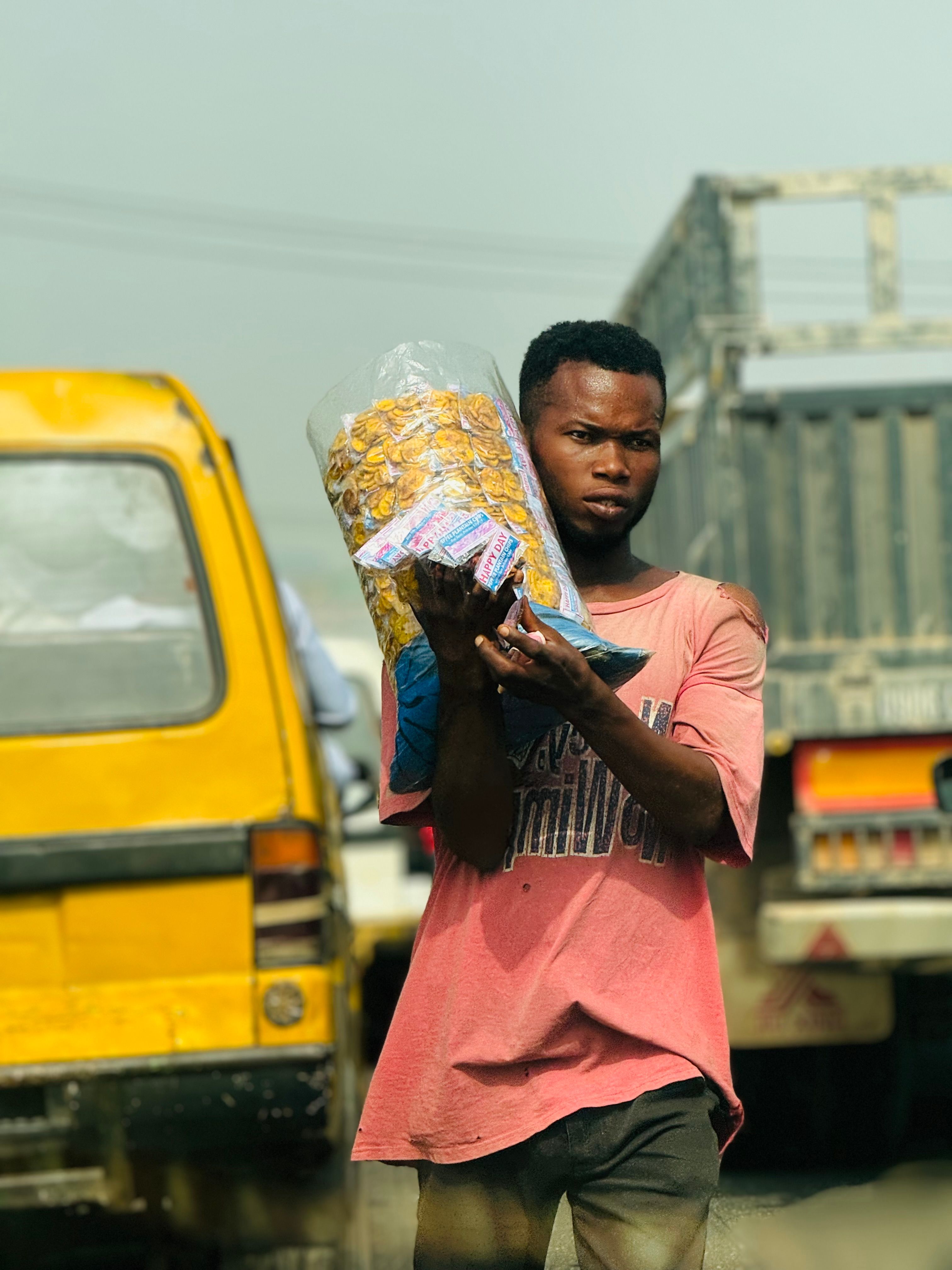 Street Vendor Selling Snacks in Urban Traffic · Free Stock Photo