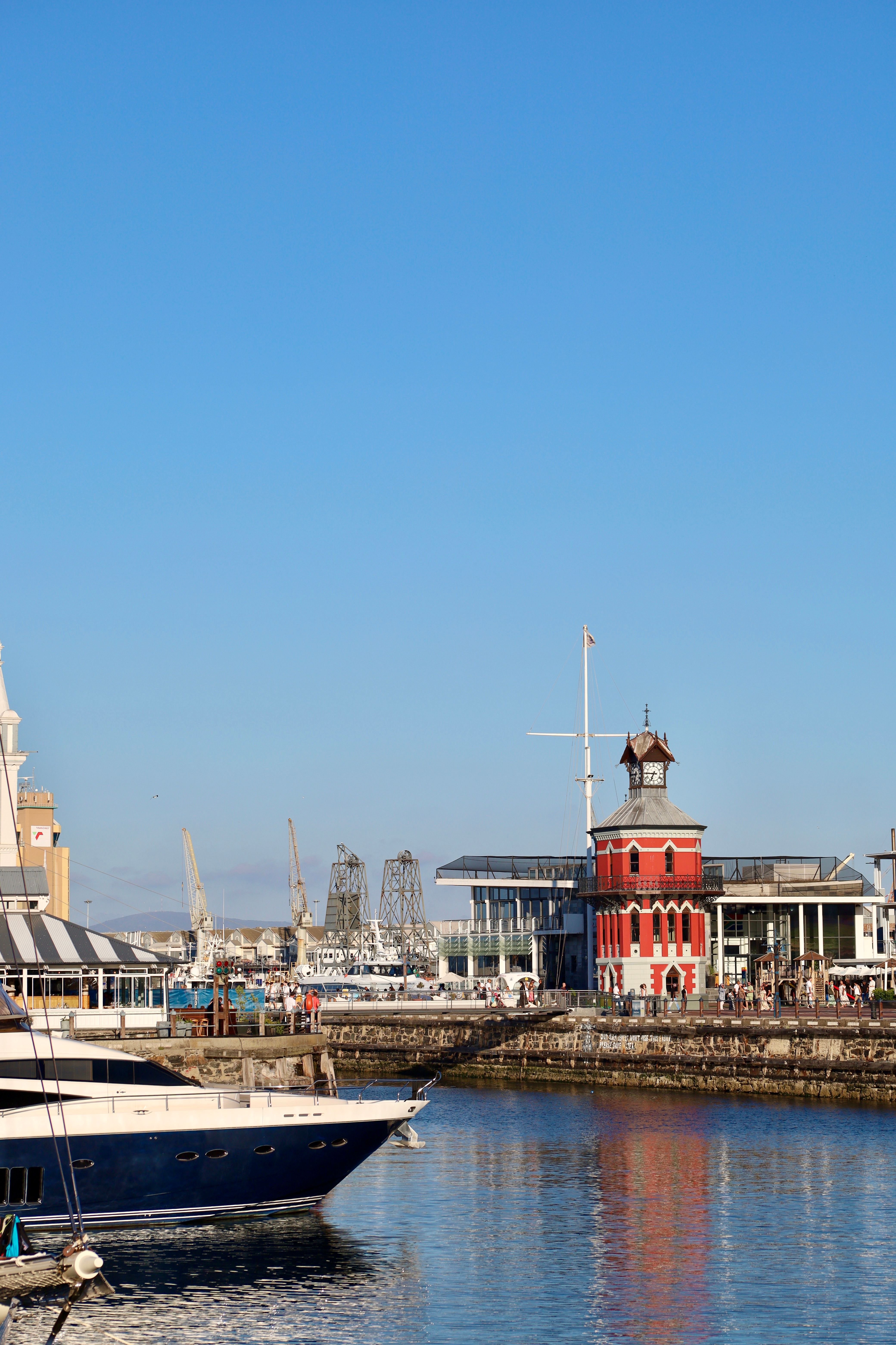 Picturesque Waterfront Harbor with Lighthouse · Free Stock Photo