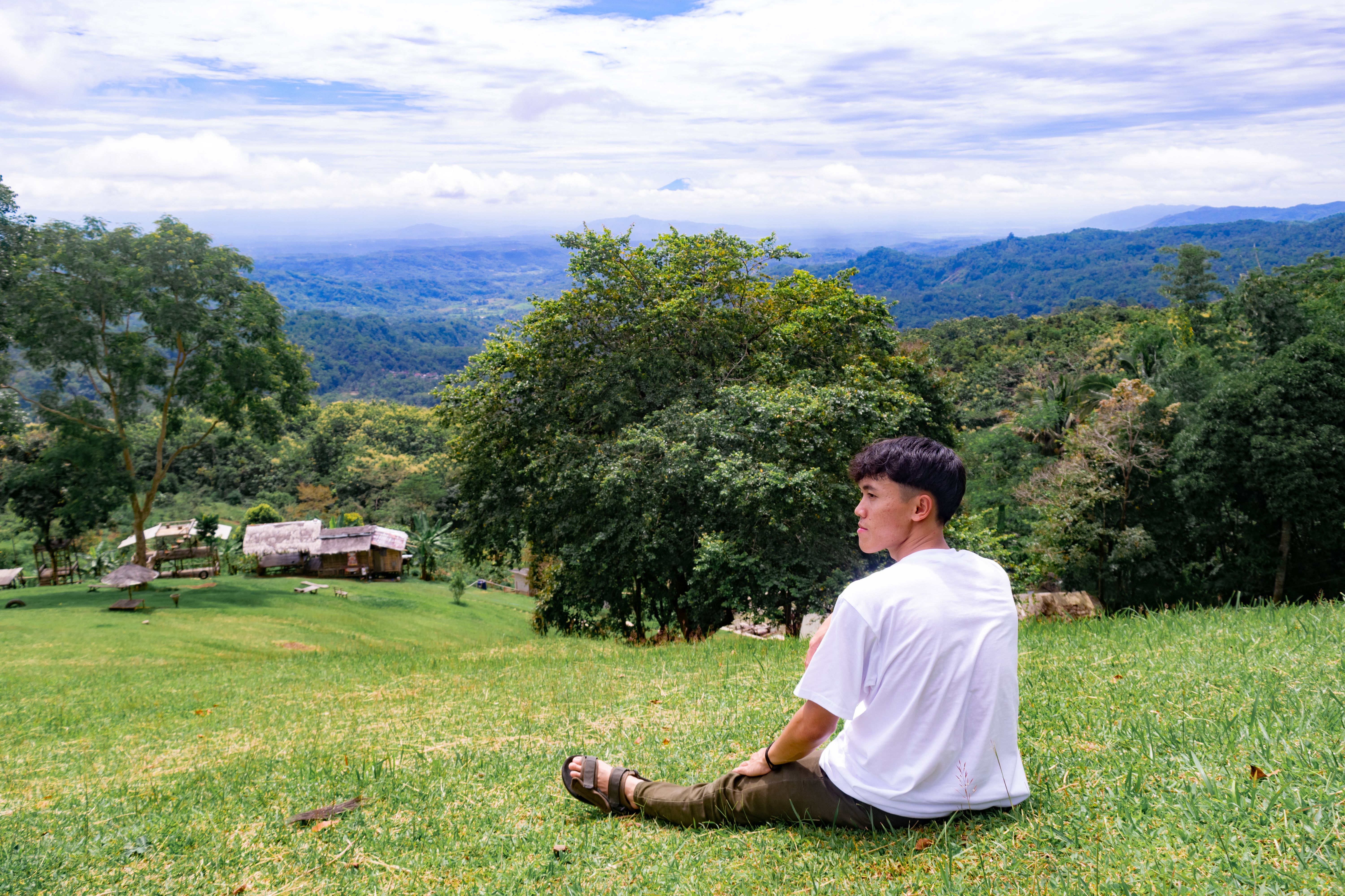 Scenic View of Mountains with Person Relaxing Outdoors · Free Stock Photo