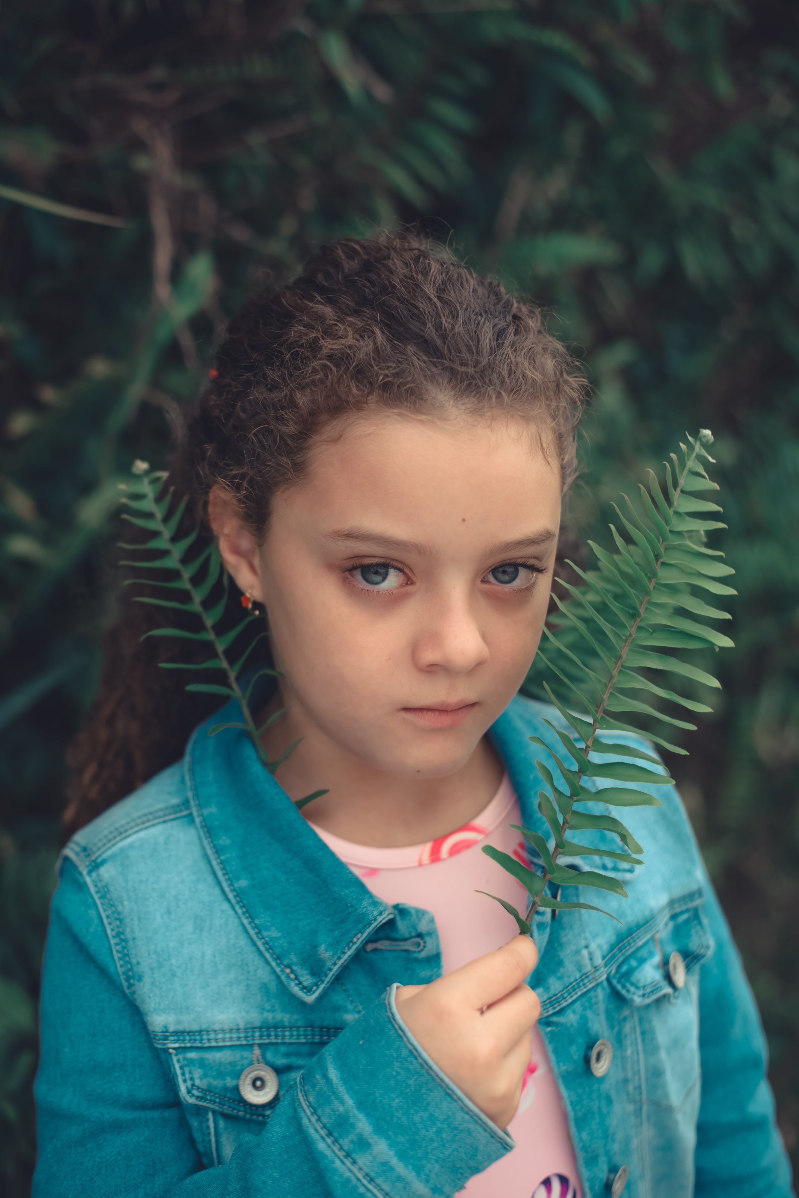 Portrait of Girl Holding Fern Leaves Outdoors · Free Stock Photo