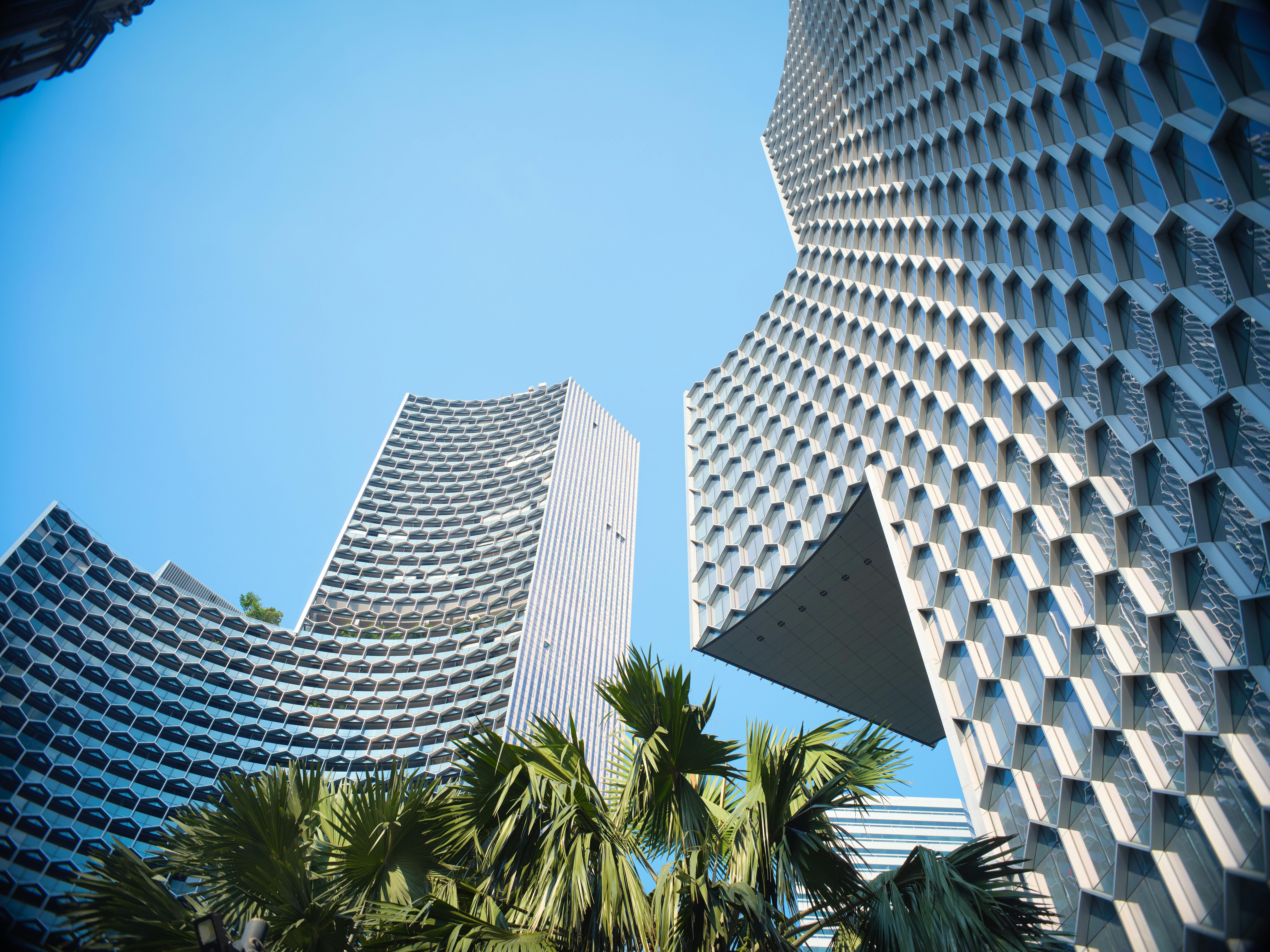 Futuristic Geometric Skyscrapers against Clear Blue Sky · Free Stock Photo