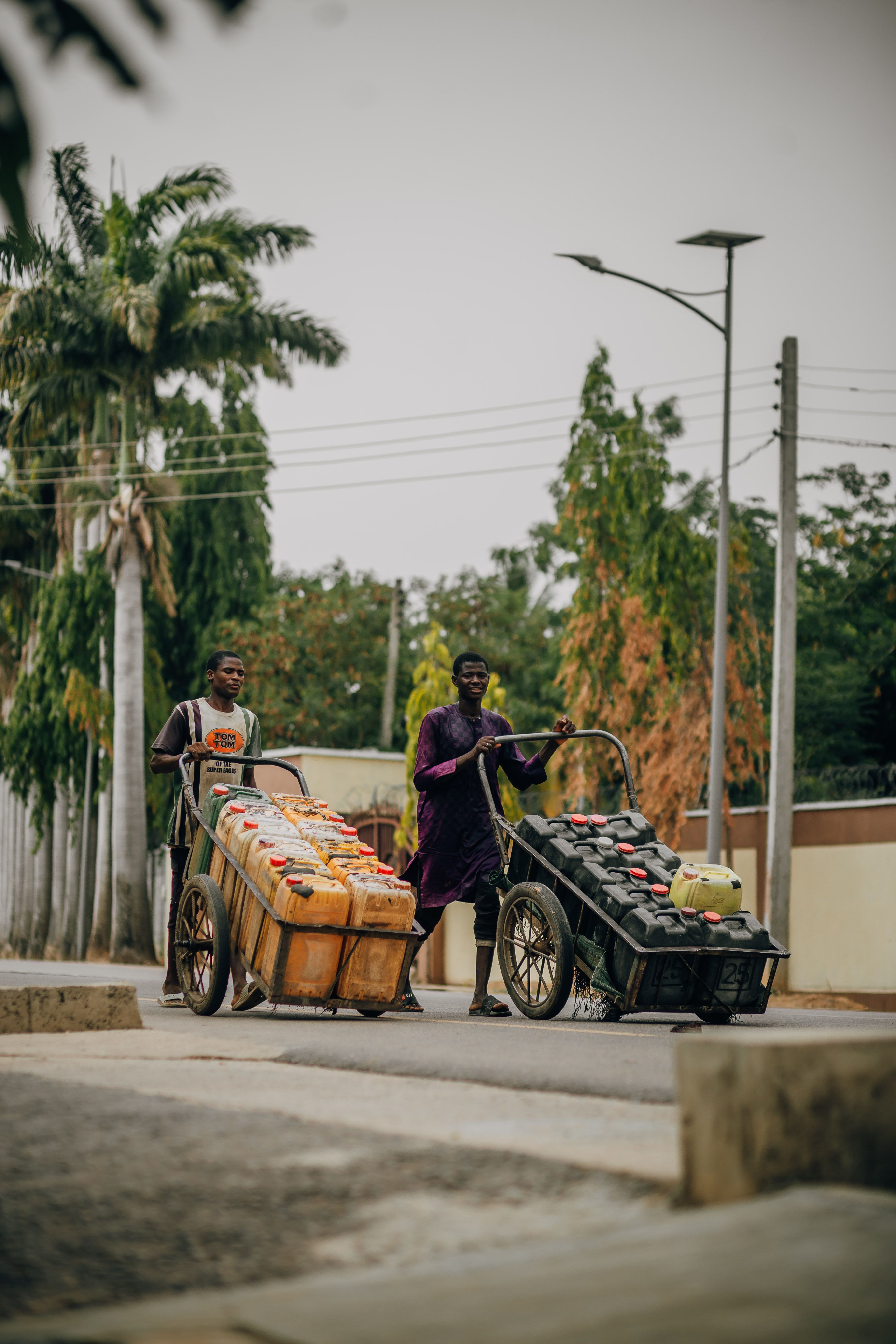 Street Vendors Pushing Carts with Colorful Goods · Free Stock Photo