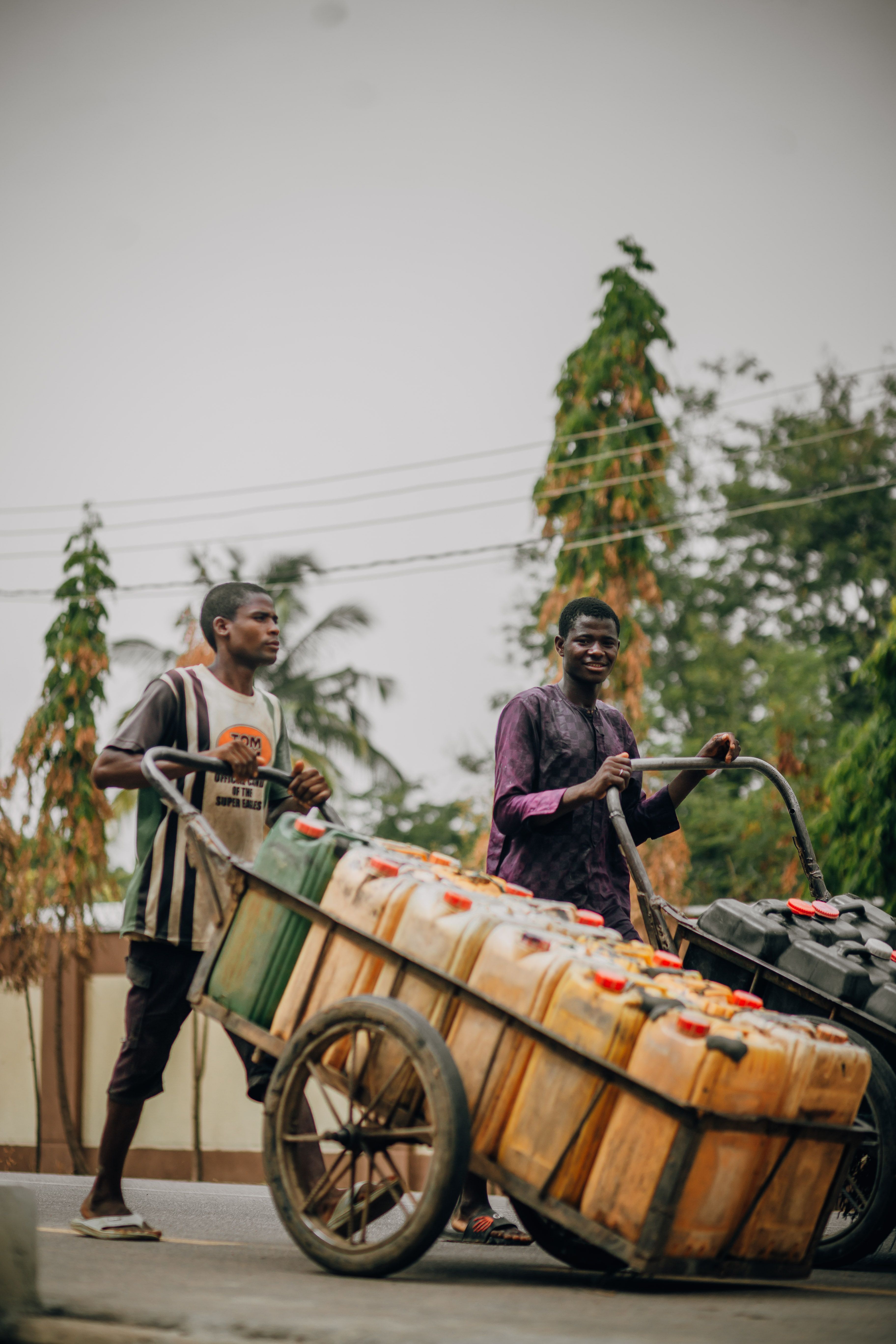 Street Vendors Transporting Goods in Urban Area · Free Stock Photo