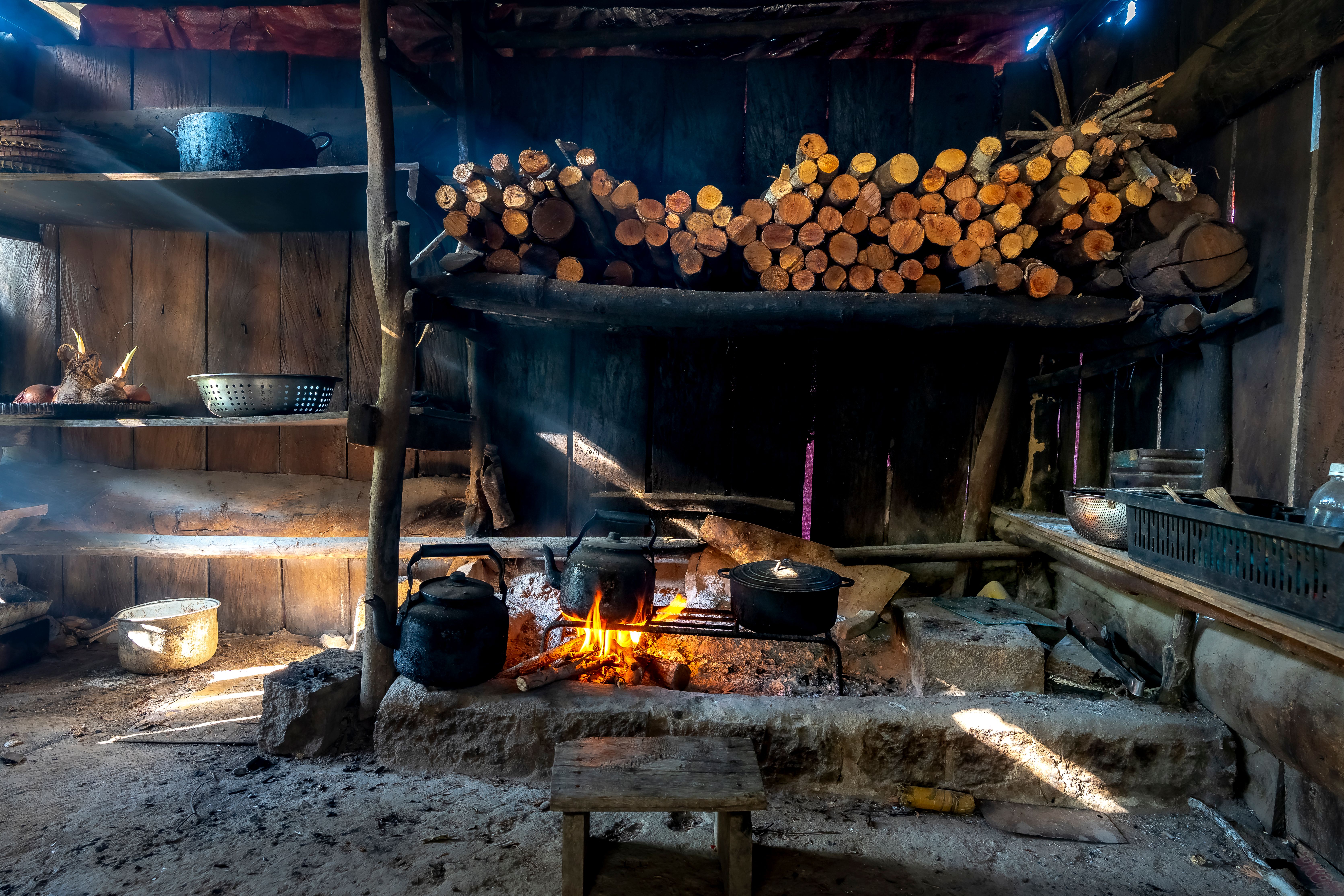 Rustic Kitchen with Firewood and Cooking Fire · Free Stock Photo