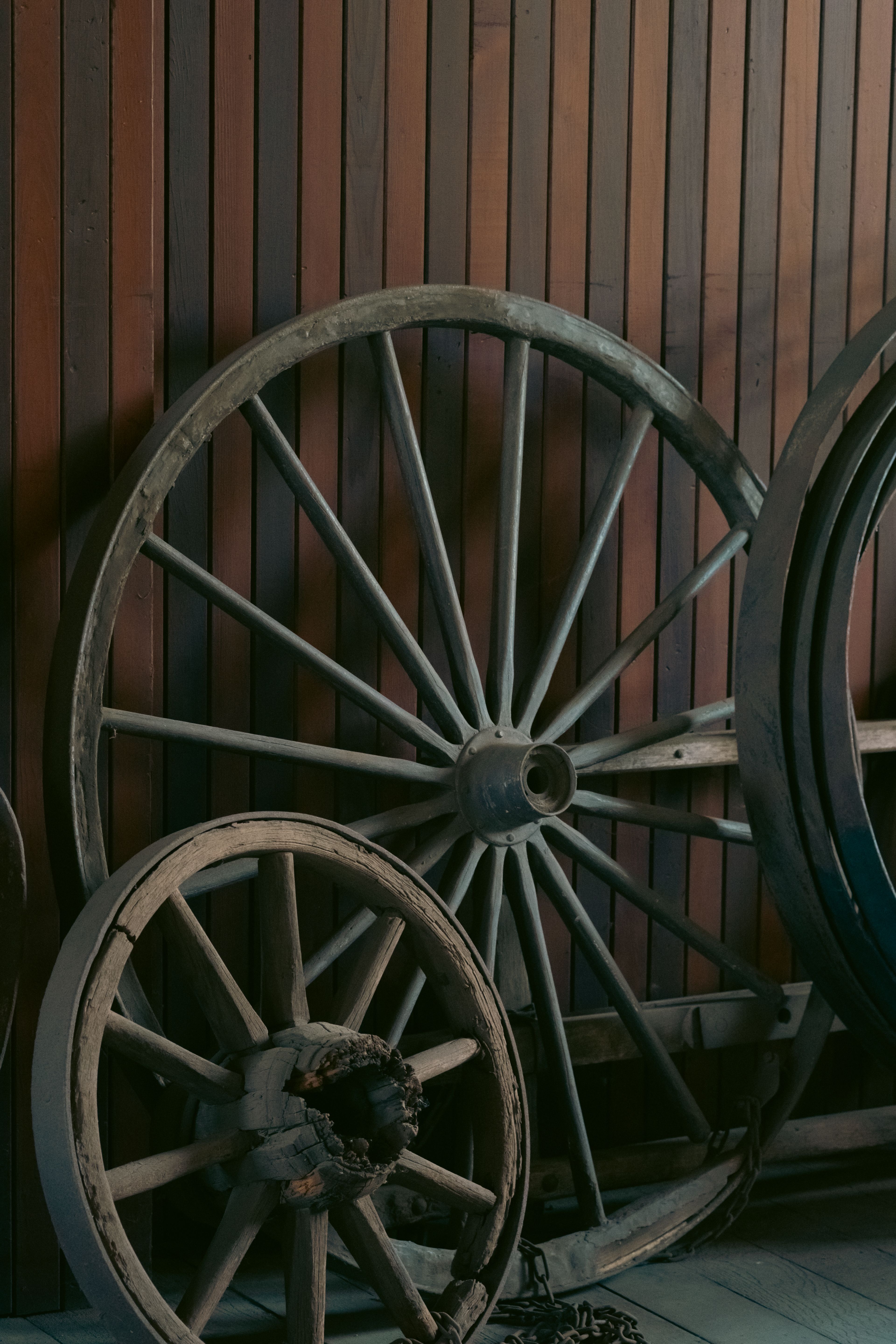 Vintage Wooden Carriage Wheels Against Rustic Background · Free Stock Photo