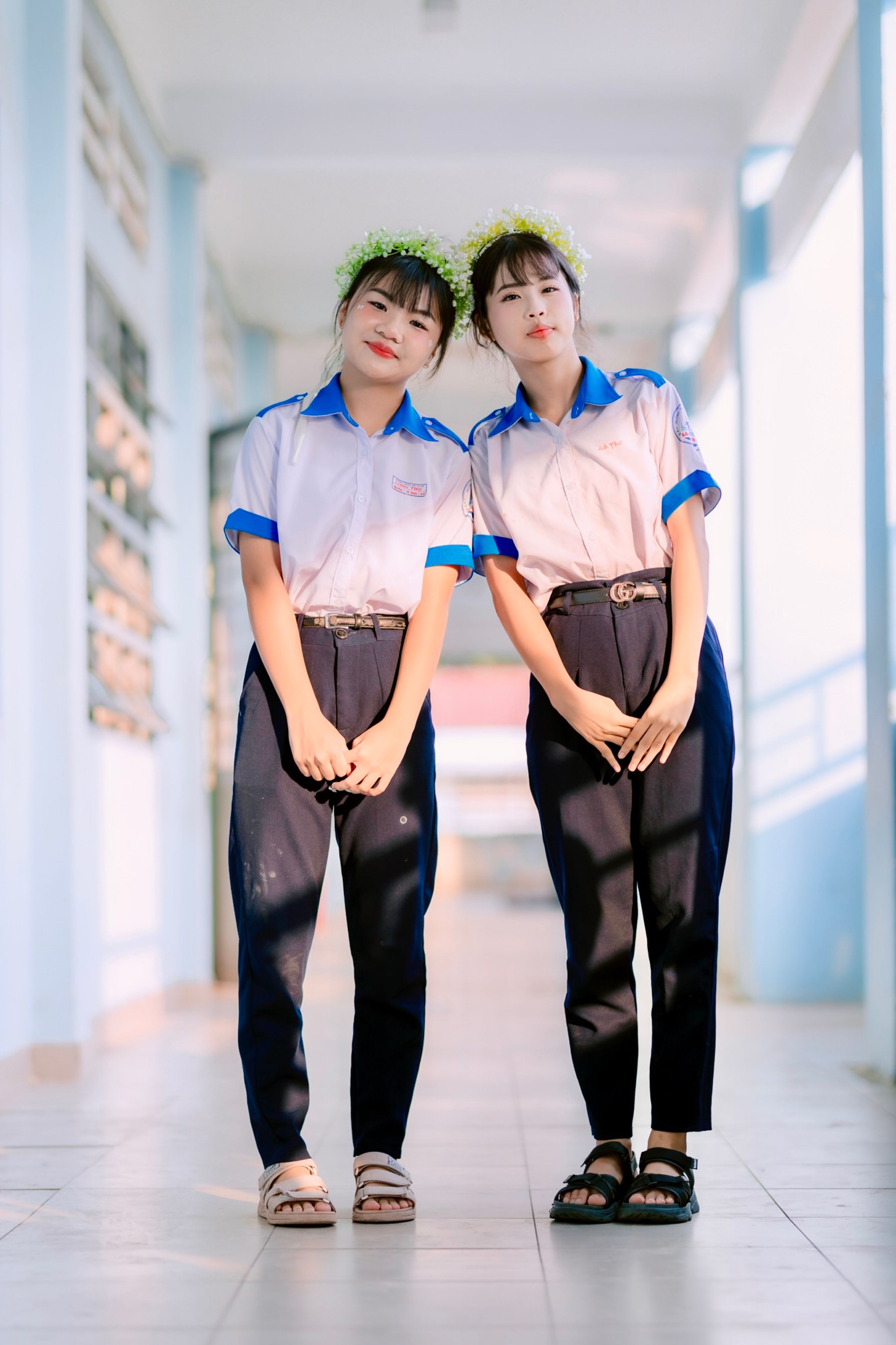 Two Students in Uniform Standing Indoors · Free Stock Photo