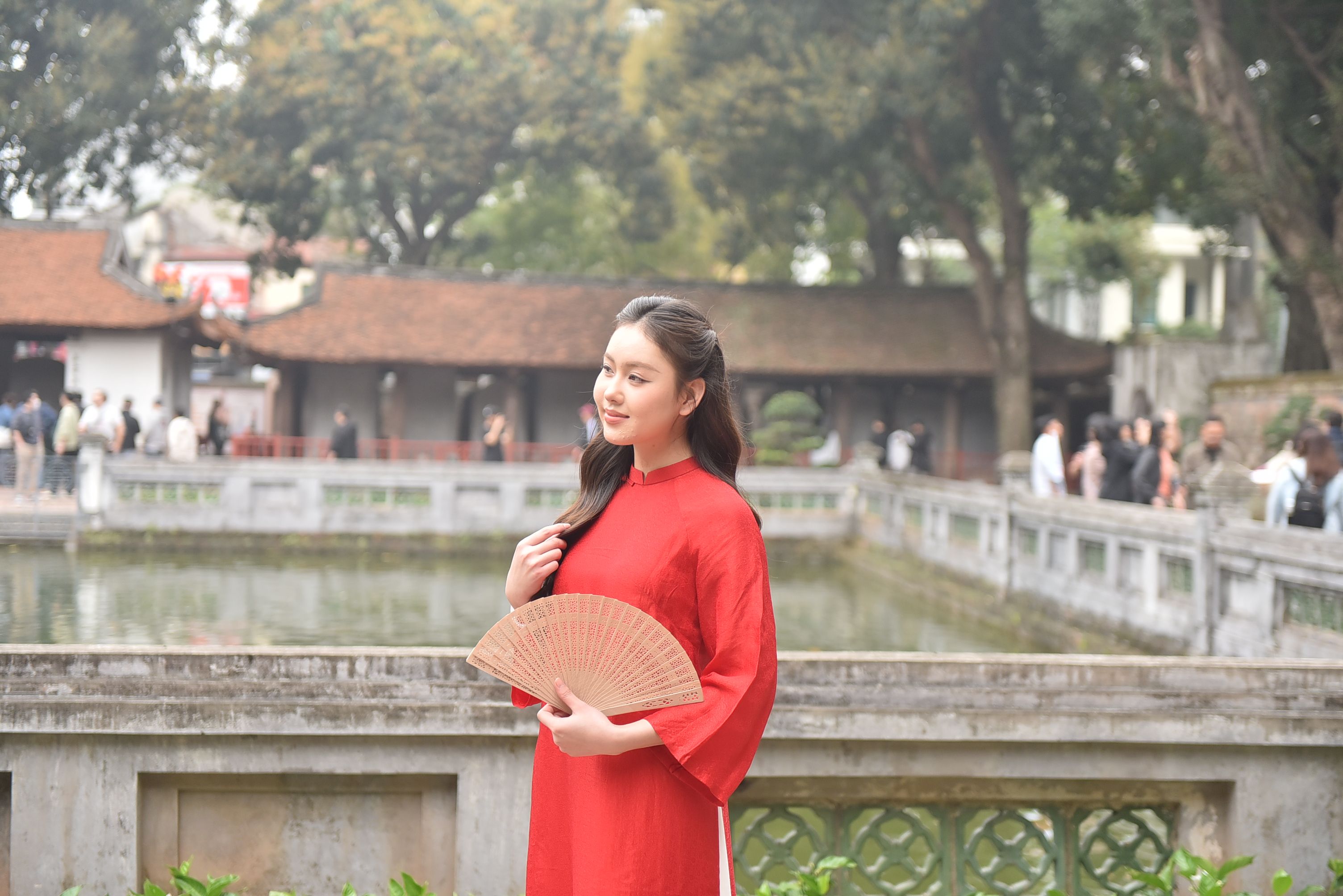 Young Woman in Traditional Red Dress with Fan Outdoors · Free Stock Photo
