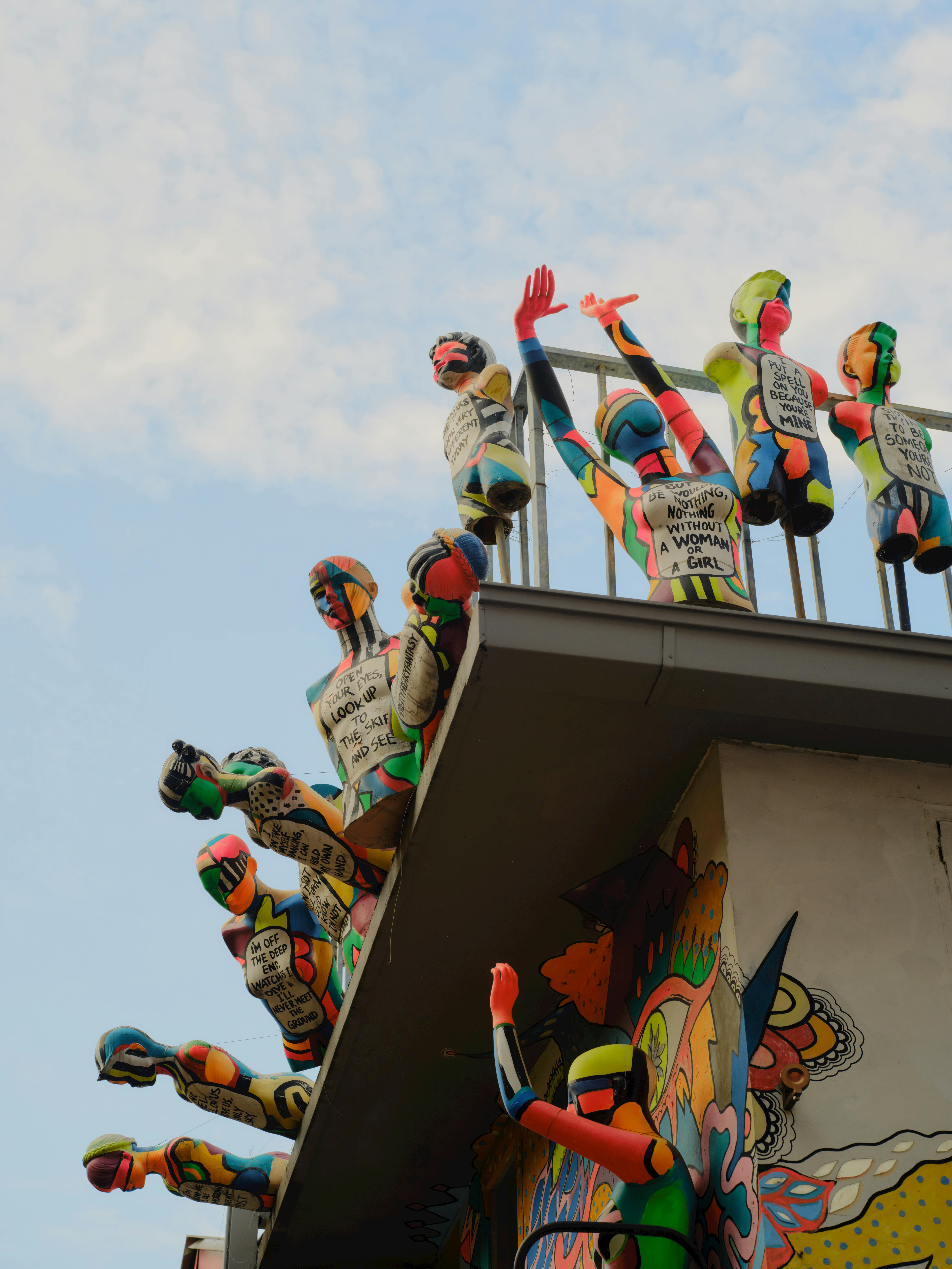 Vibrant Sculptures on Building Rooftop · Free Stock Photo