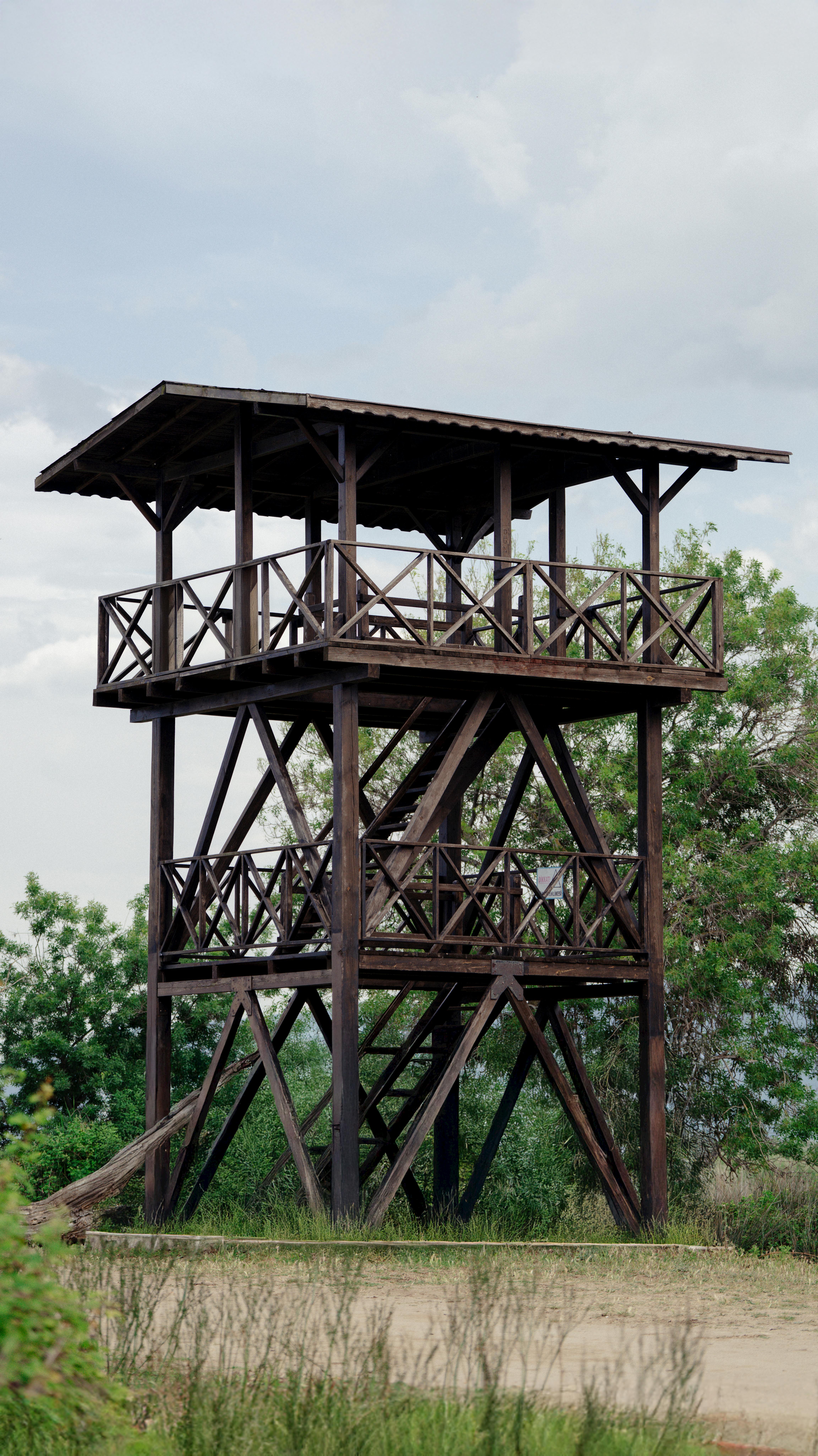 Rustic Wooden Watchtower Set Against Cloudy Sky · Free Stock Photo