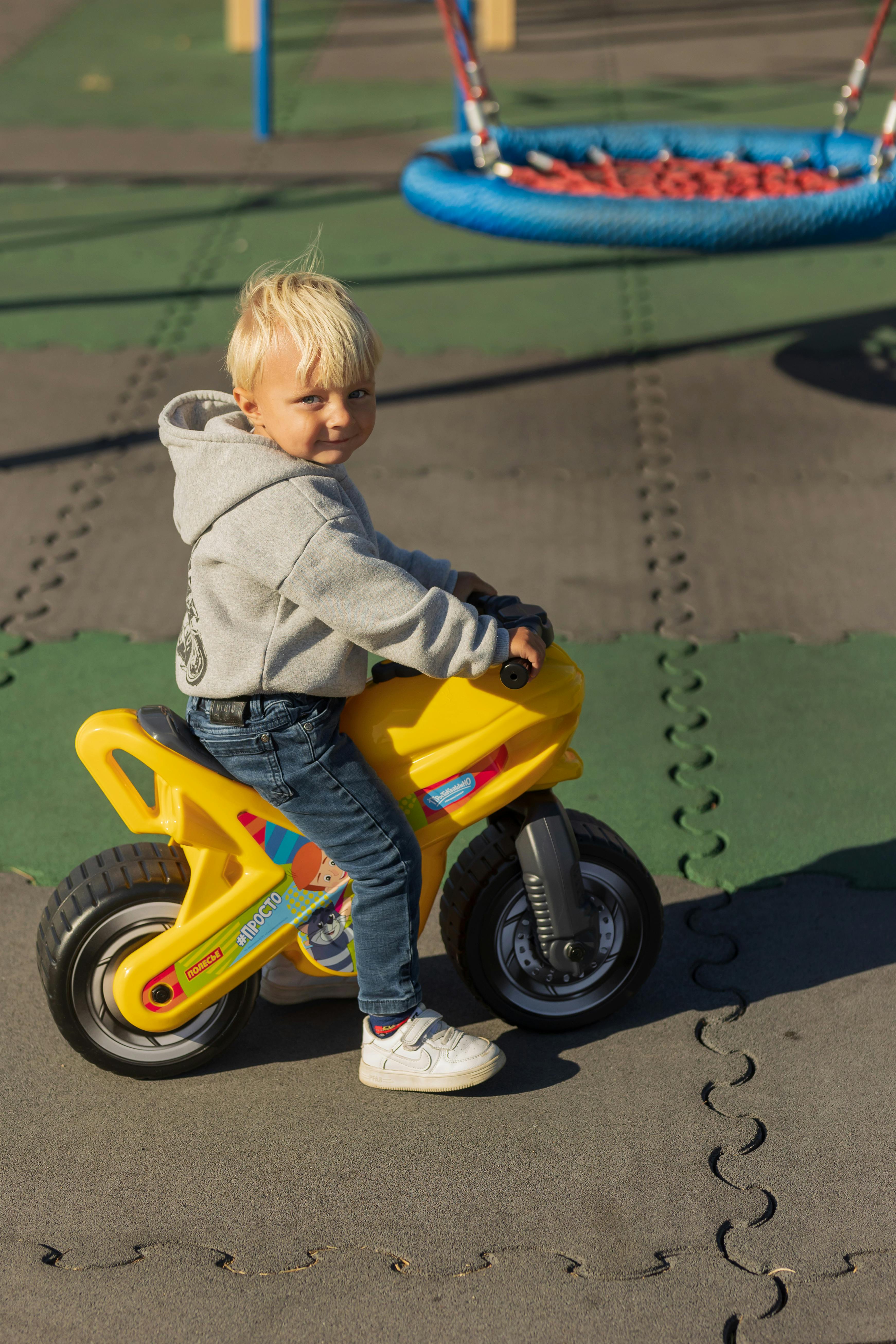Toddler Riding Toy Motorcycle in Playground · Free Stock Photo
