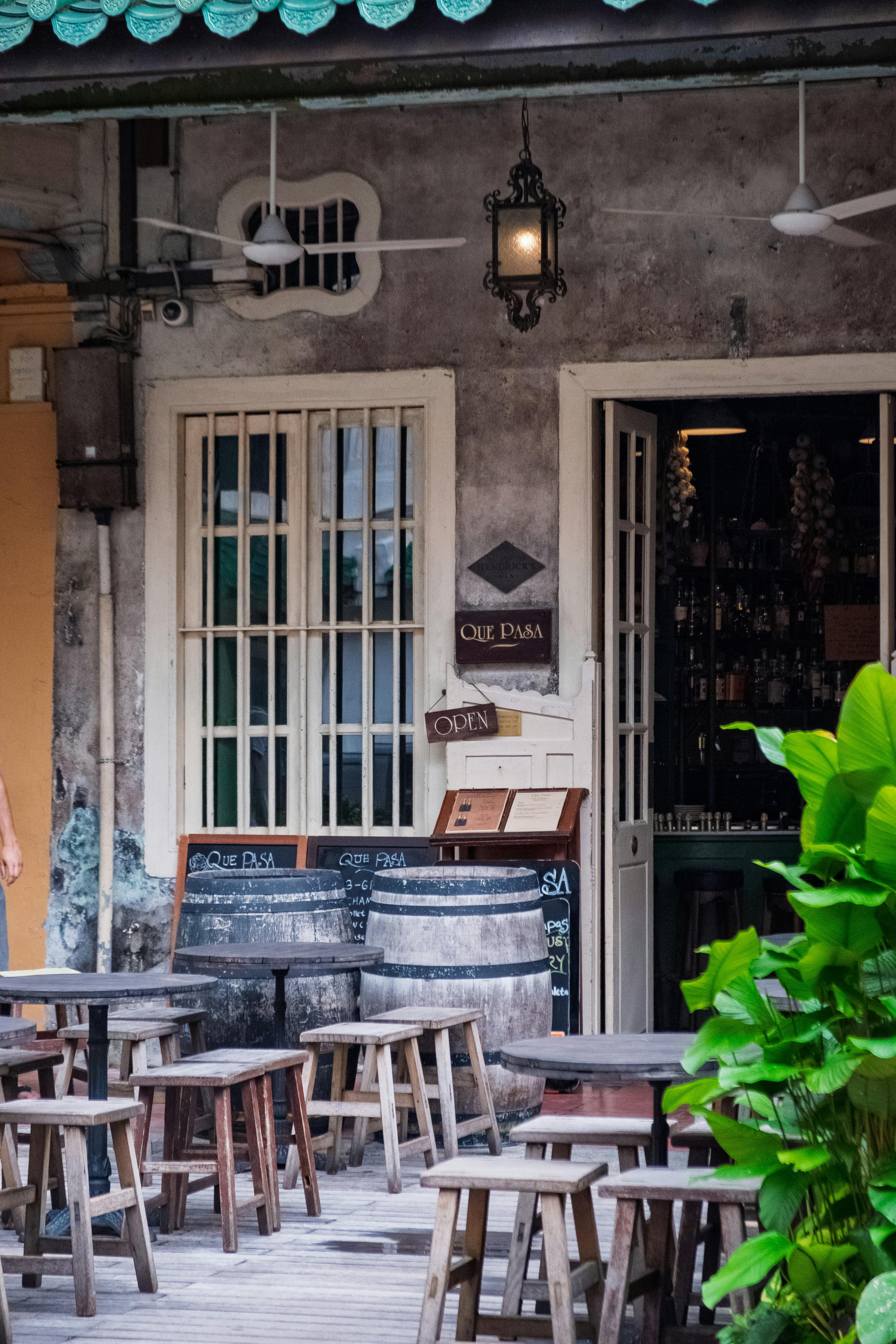 Rustic Outdoor Café with Wooden Barrels and Tables · Free Stock Photo