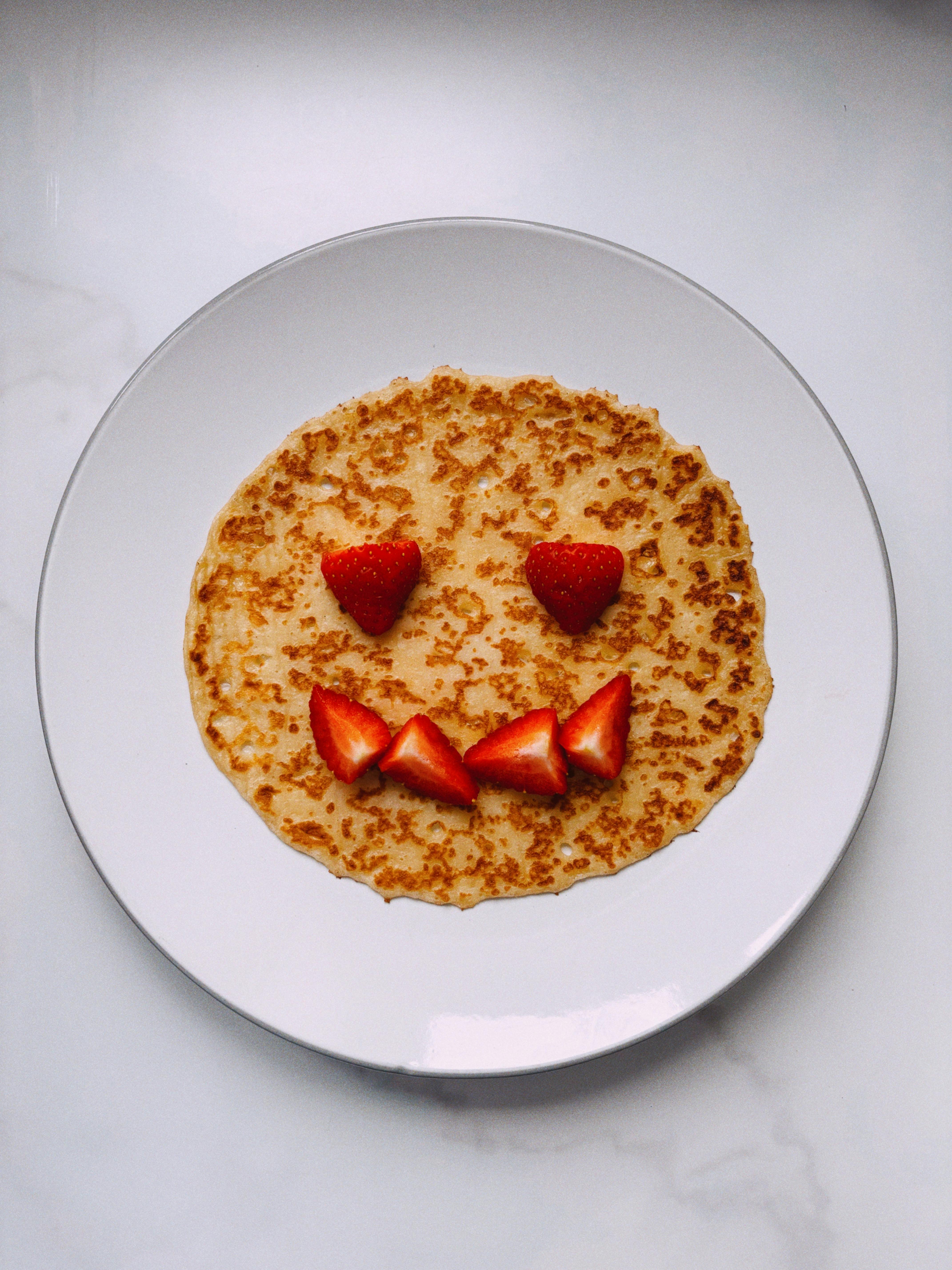 Pancake Face with Strawberries on White Plate · Free Stock Photo