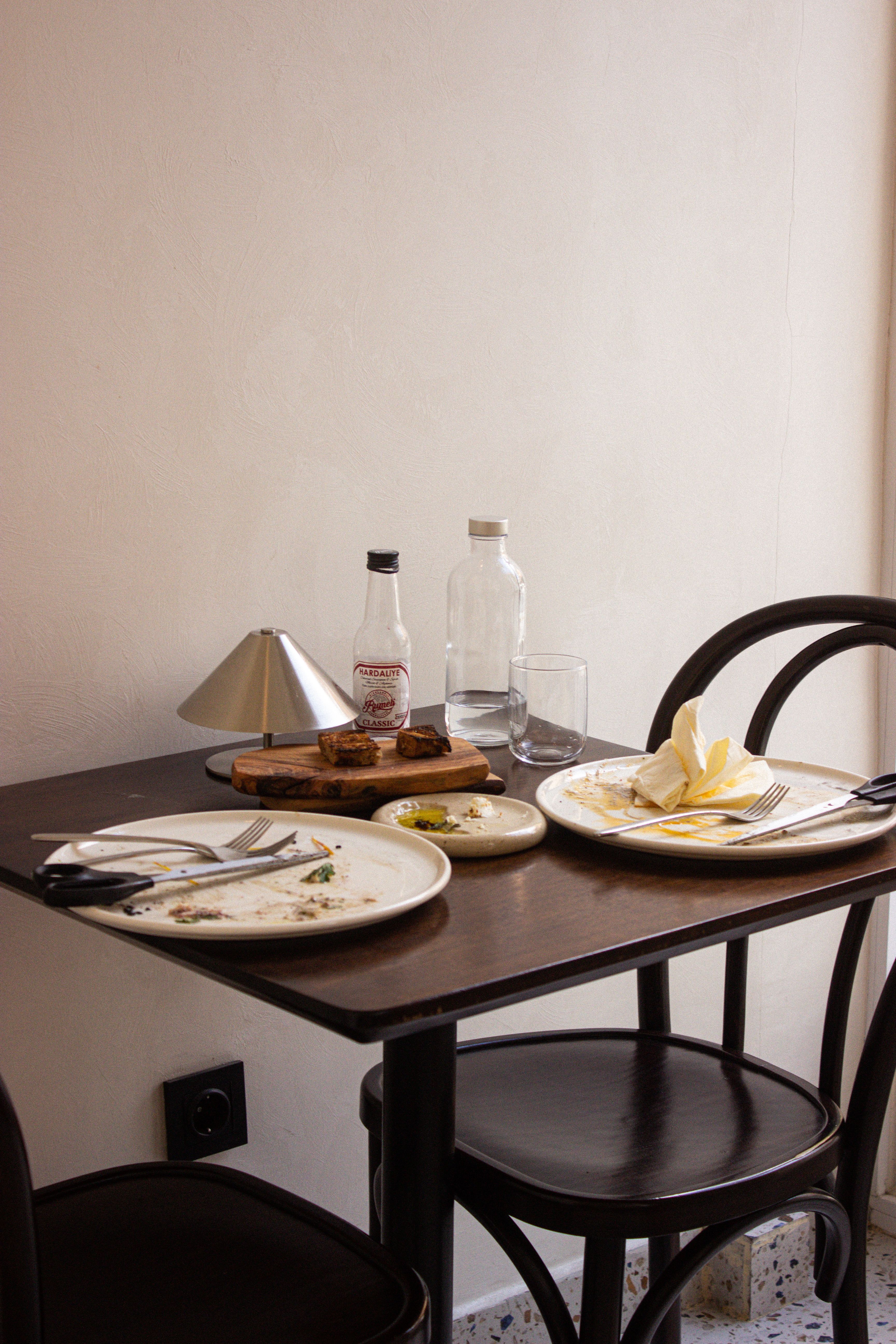 Cozy Café Table with Plates After Meal · Free Stock Photo