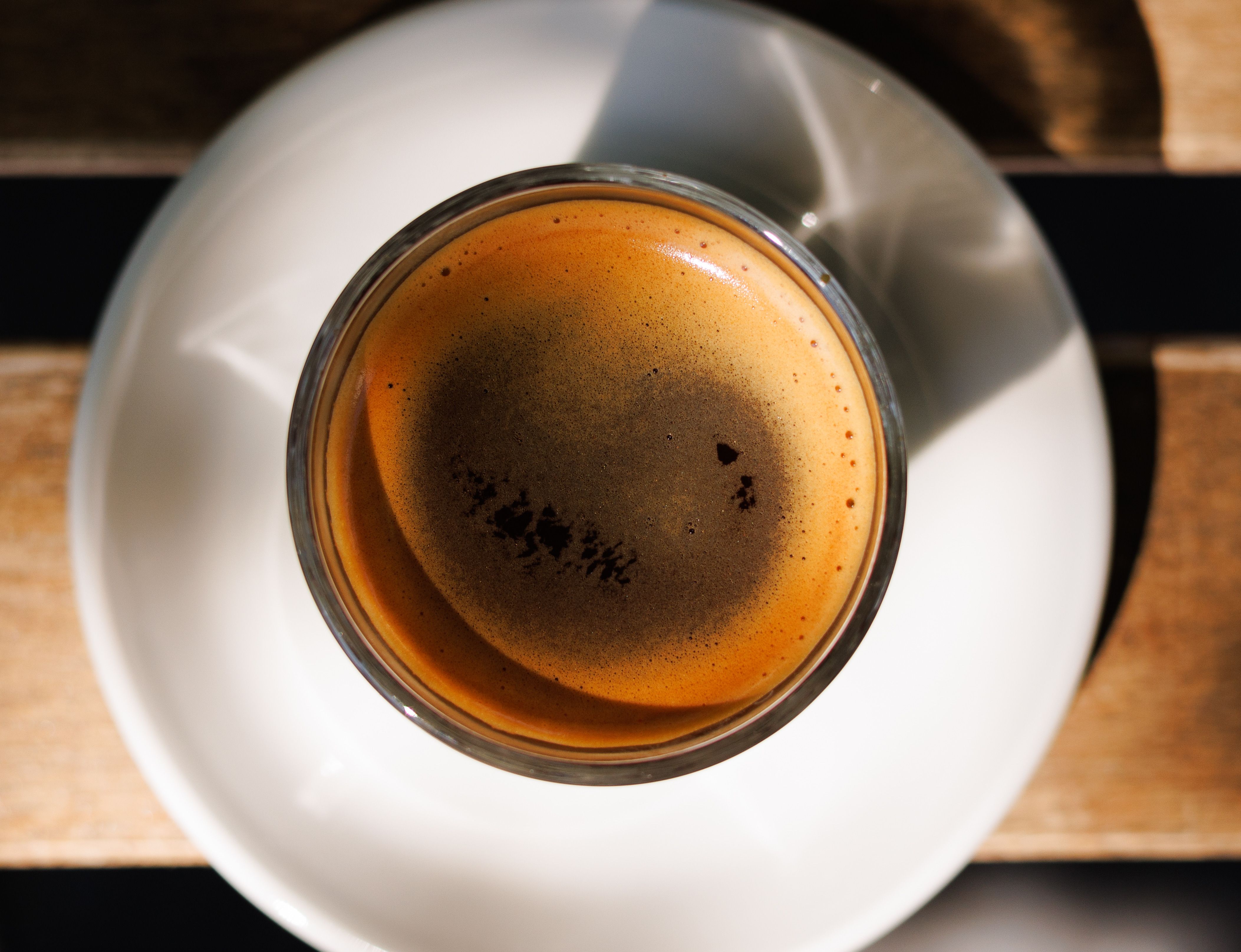 Top view of freshly brewed espresso in a glass cup · Free Stock Photo