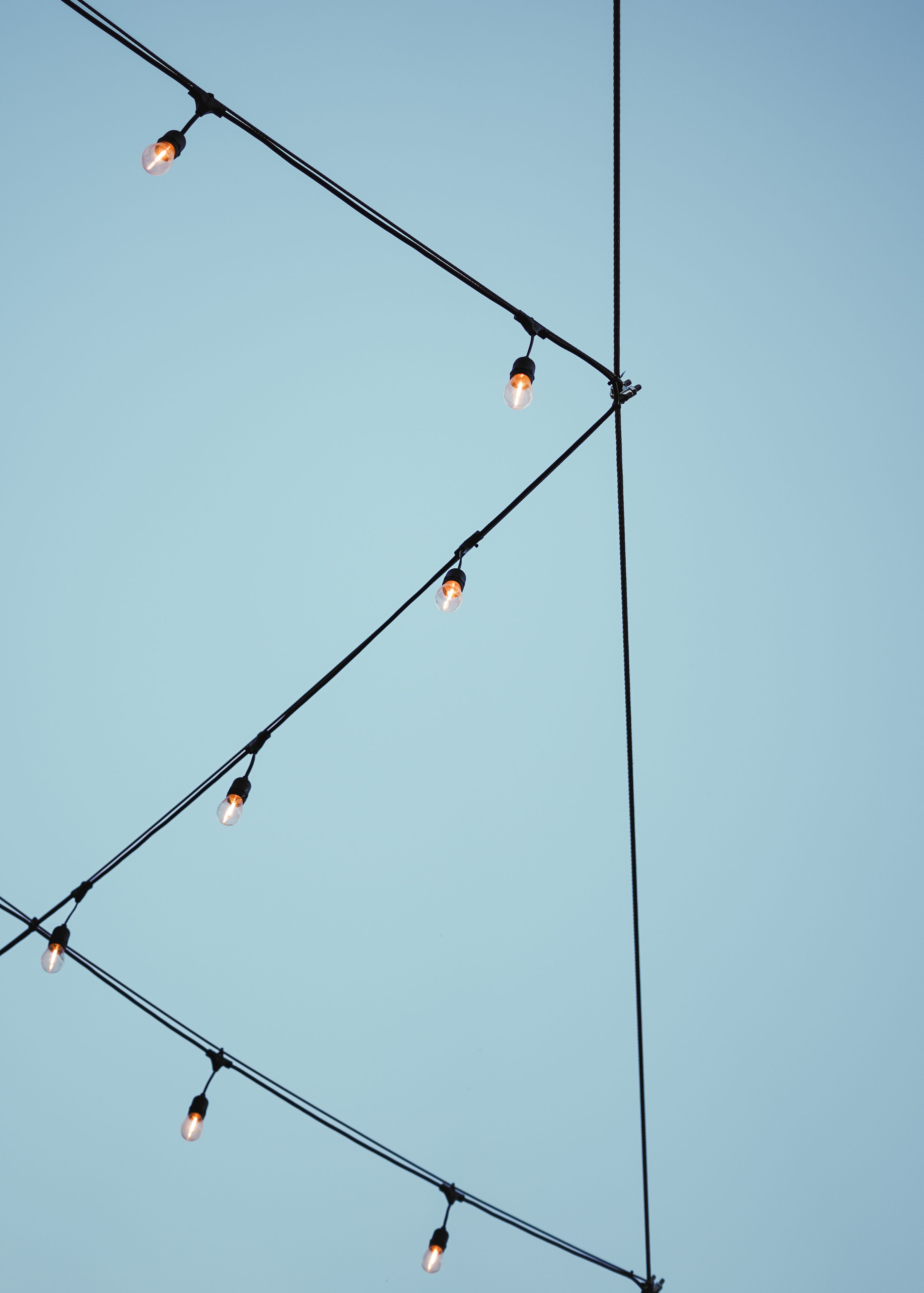 Outdoor String Lights Against Clear Blue Sky · Free Stock Photo