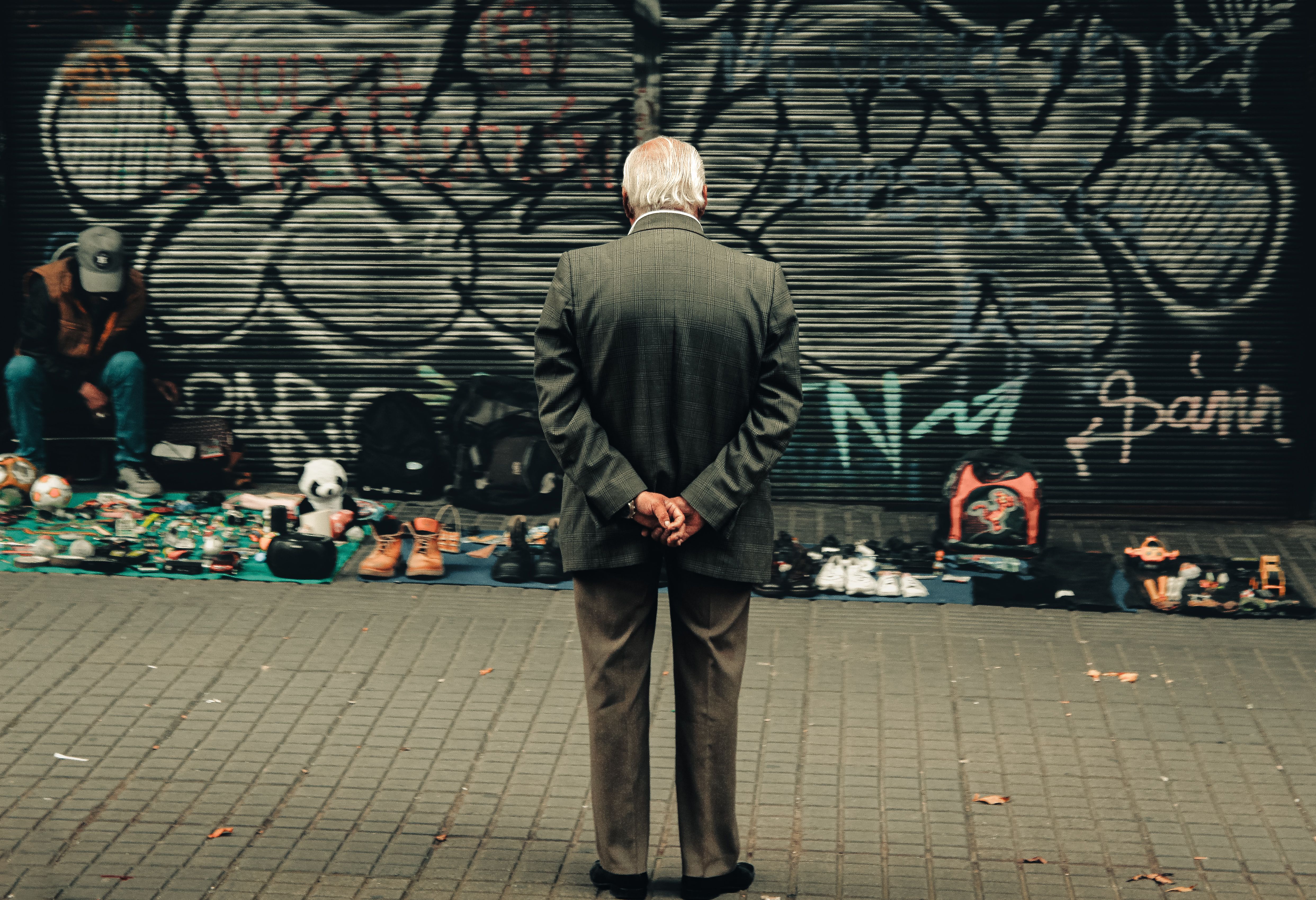 Elderly Man Observing Street Market Scene · Free Stock Photo
