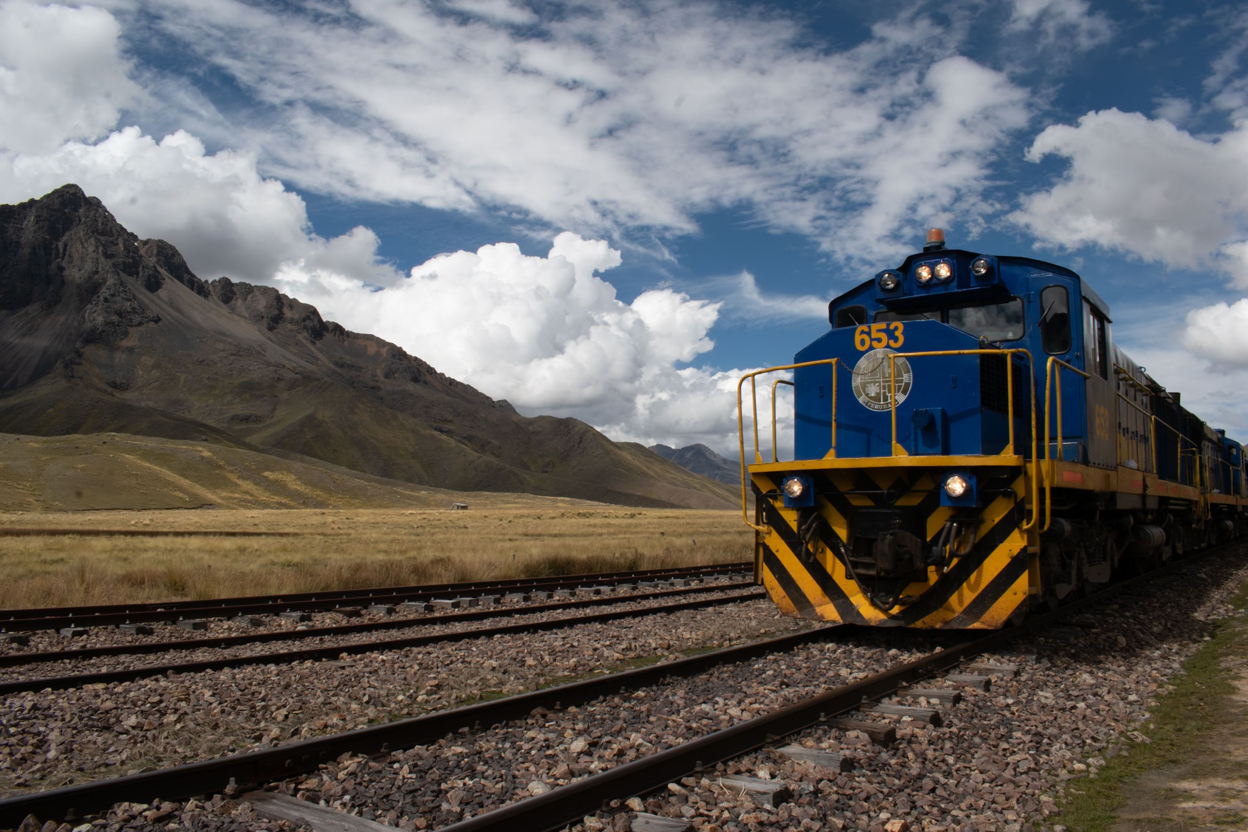 Blue Train on Scenic Mountain Railway Track · Free Stock Photo