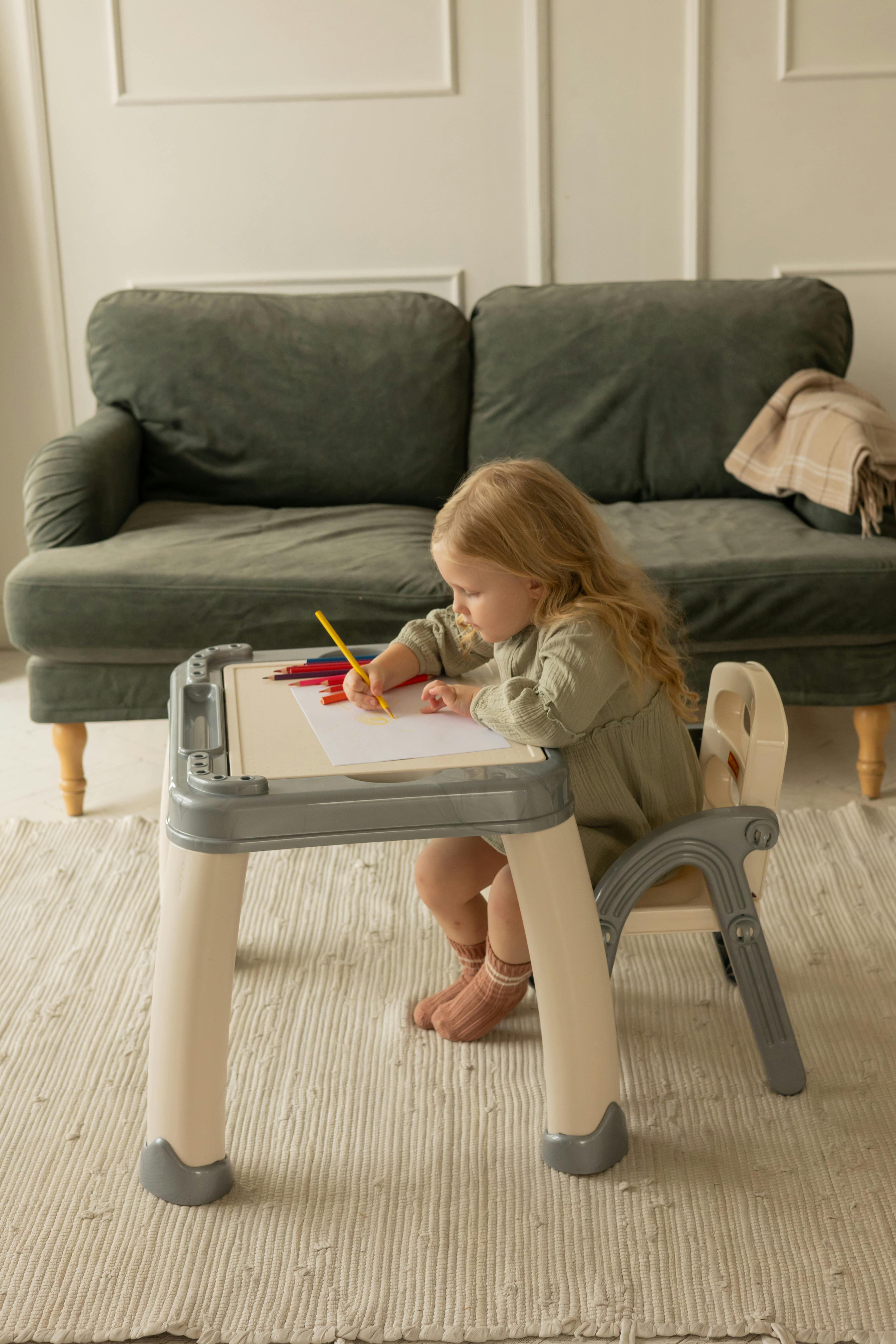 Young Child Drawing at Home on a Table · Free Stock Photo