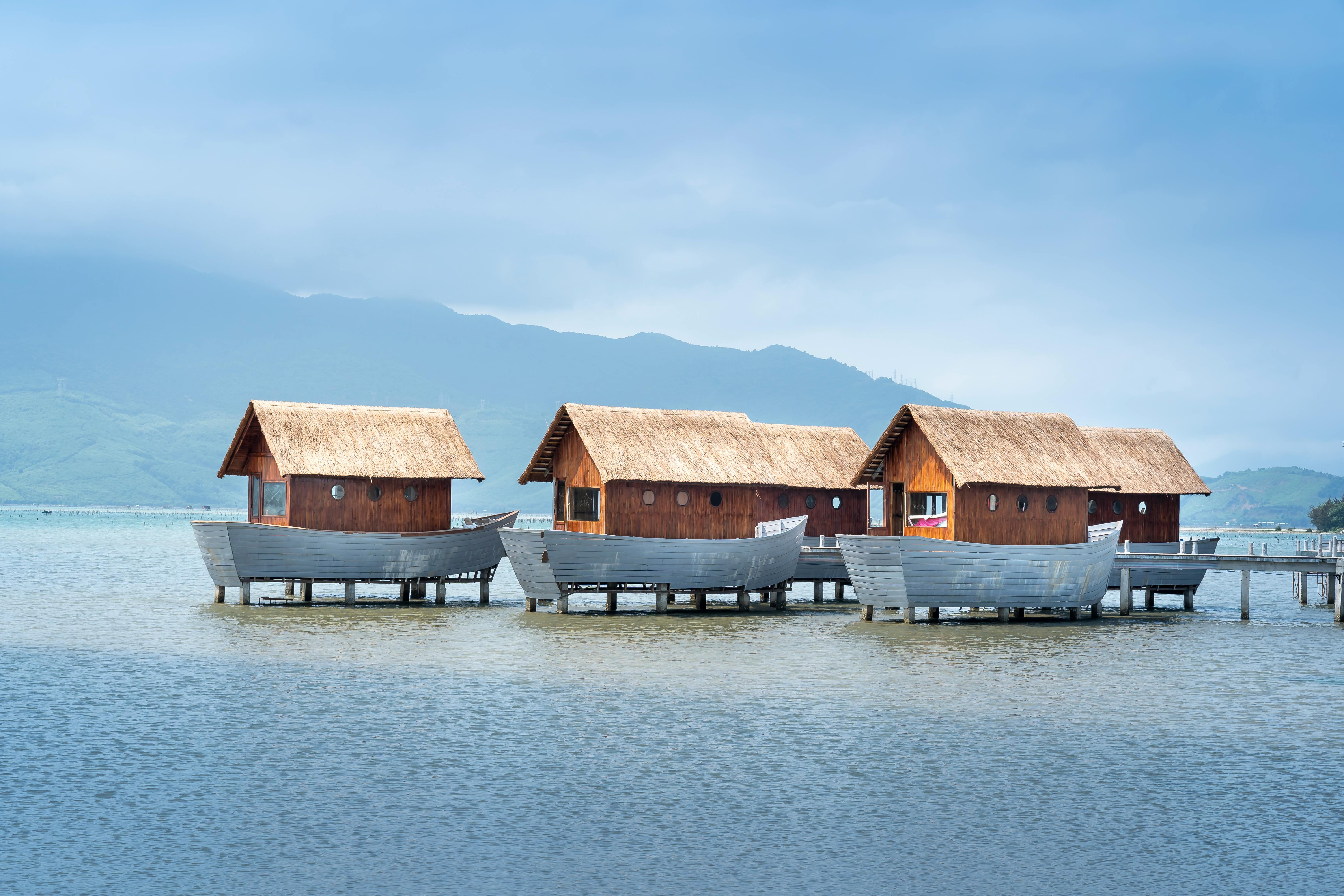 Brown Wooden Houses at Middle of Sea · Free Stock Photo