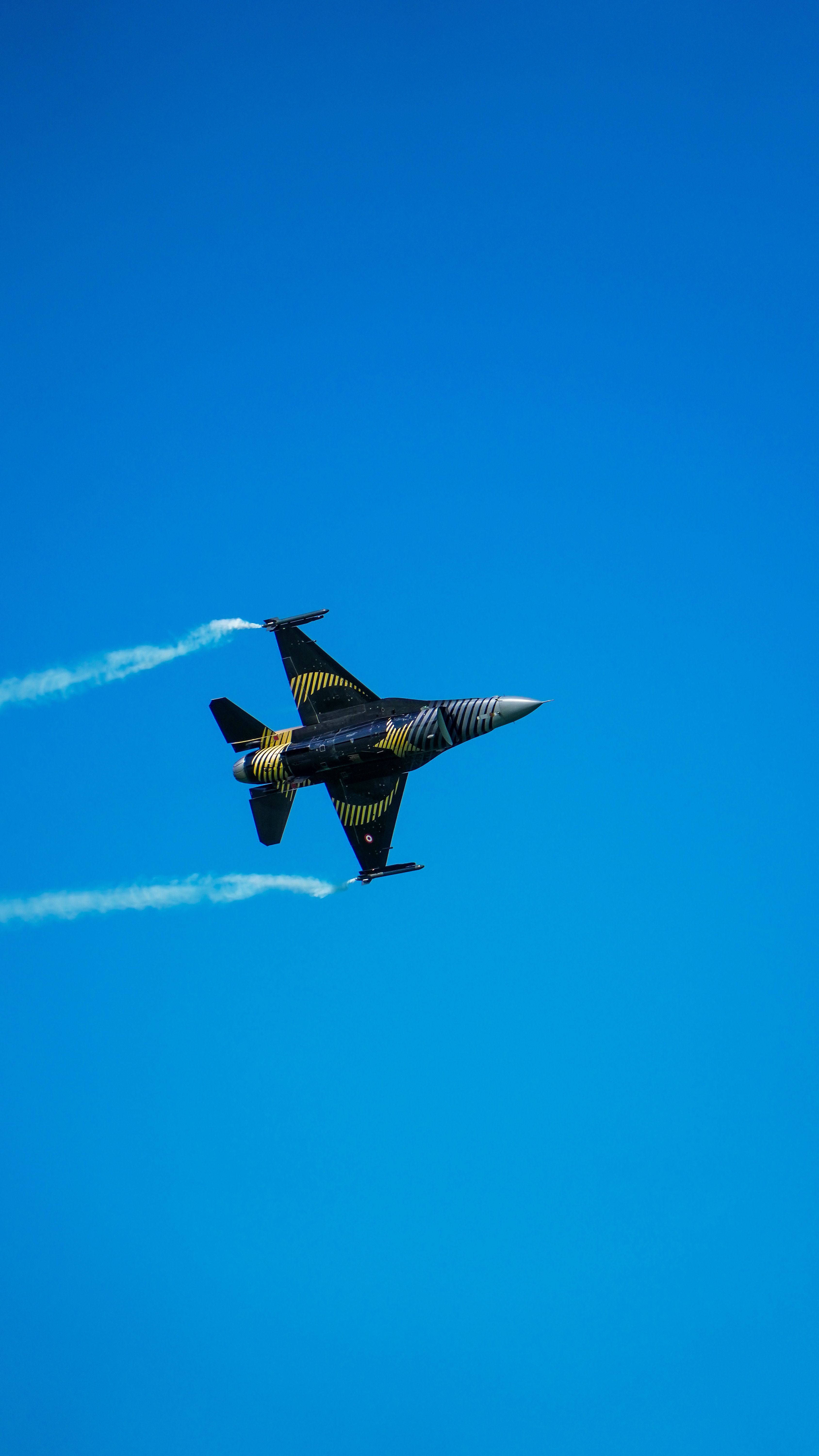 Jet Fighter Performing Aerobatic Maneuver in Clear Sky · Free Stock Photo