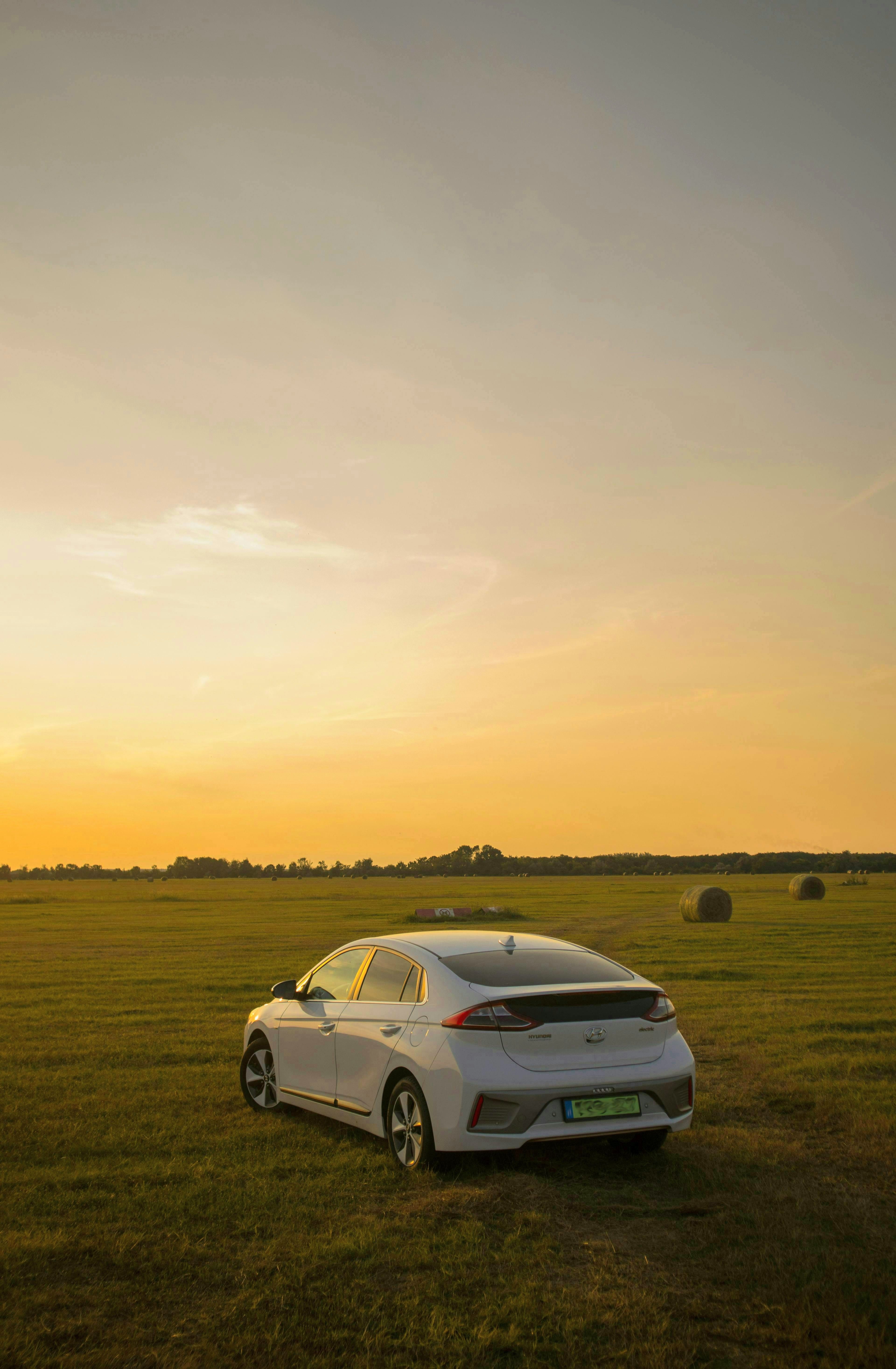 White Car Parked in Sunset Field Landscape · Free Stock Photo
