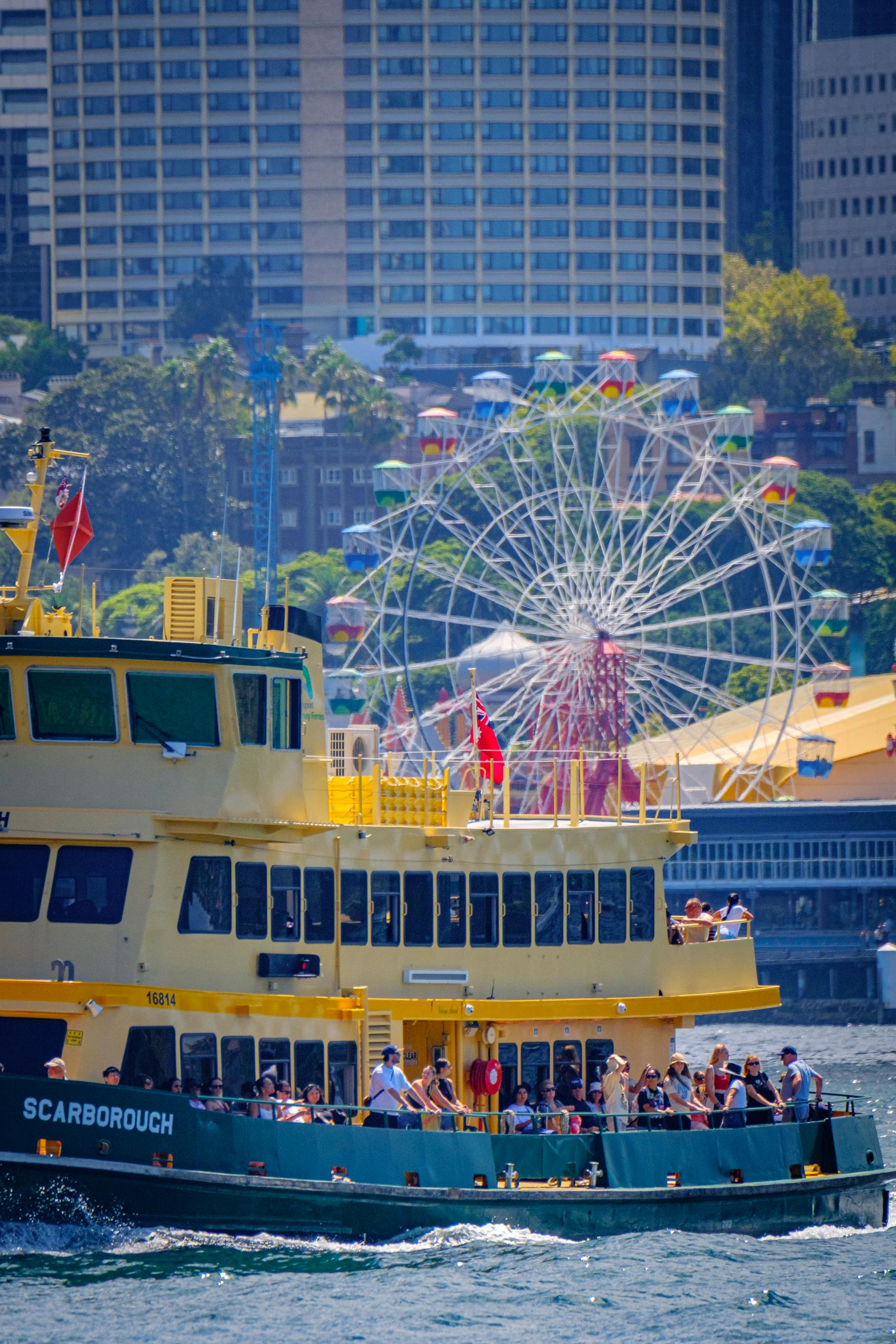 Sydney Ferry with Scenic Ferris Wheel in Background · Free Stock Photo