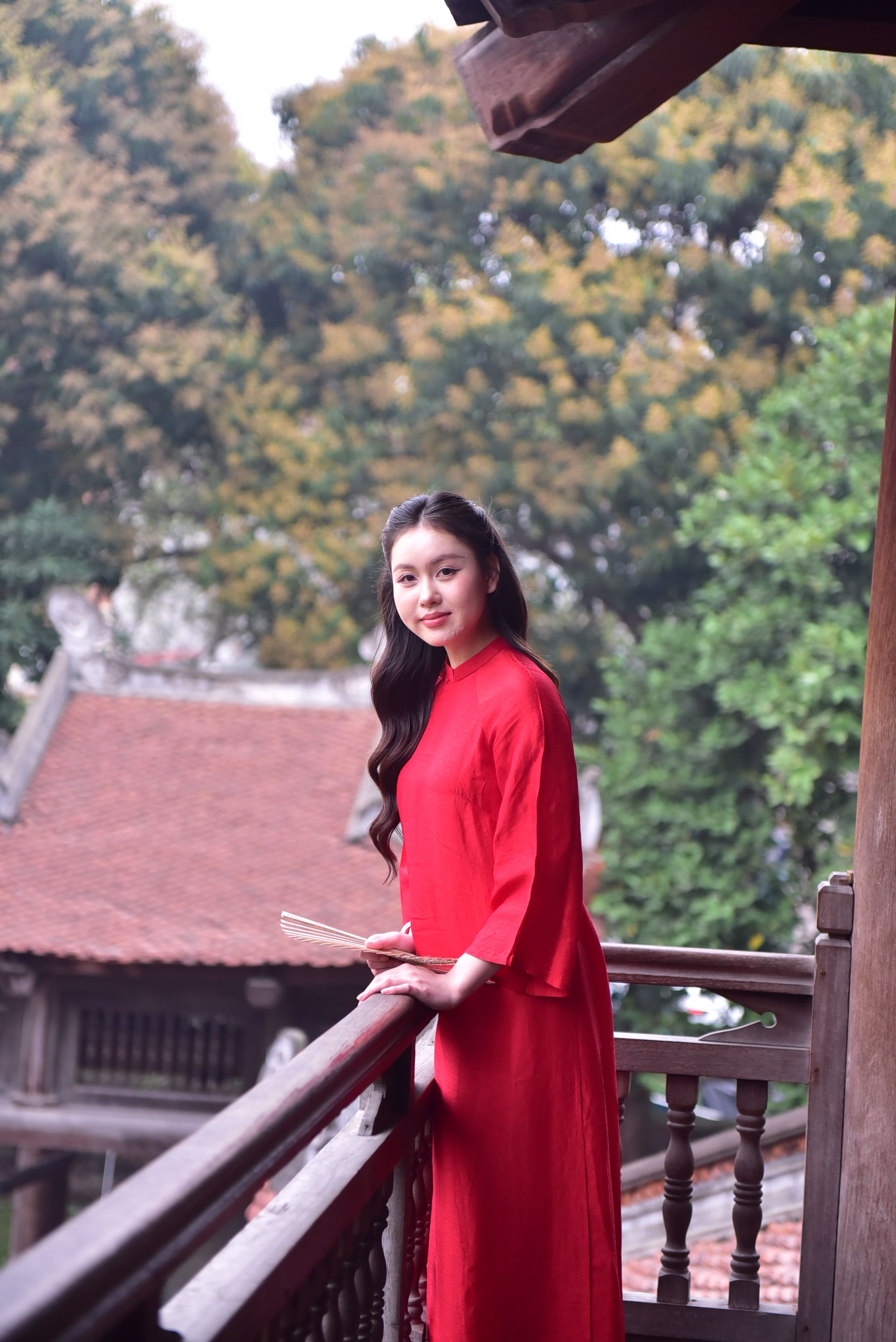 Young Woman in Traditional Red Dress on Balcony · Free Stock Photo