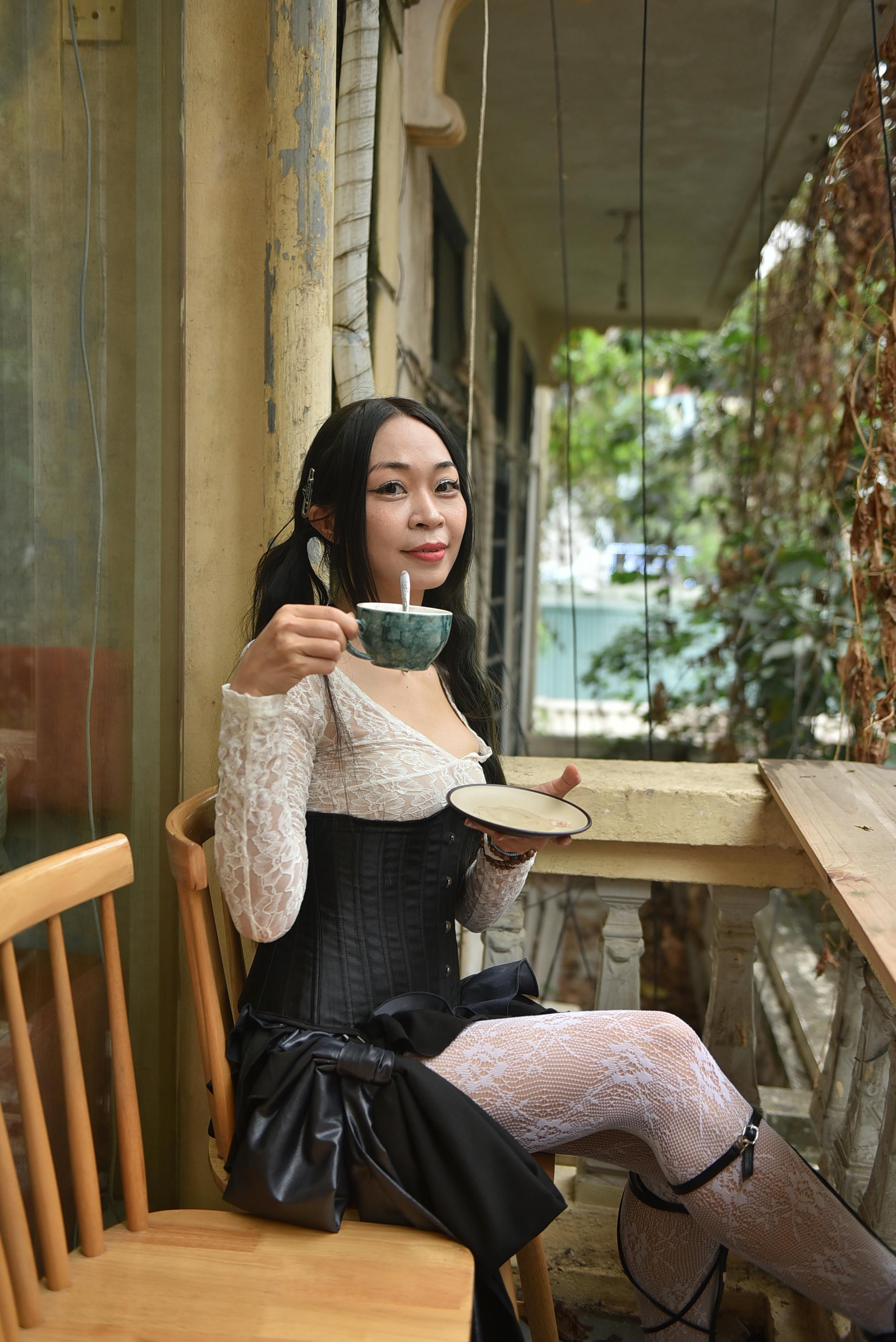 Woman in Corset Enjoying Coffee on Balcony · Free Stock Photo