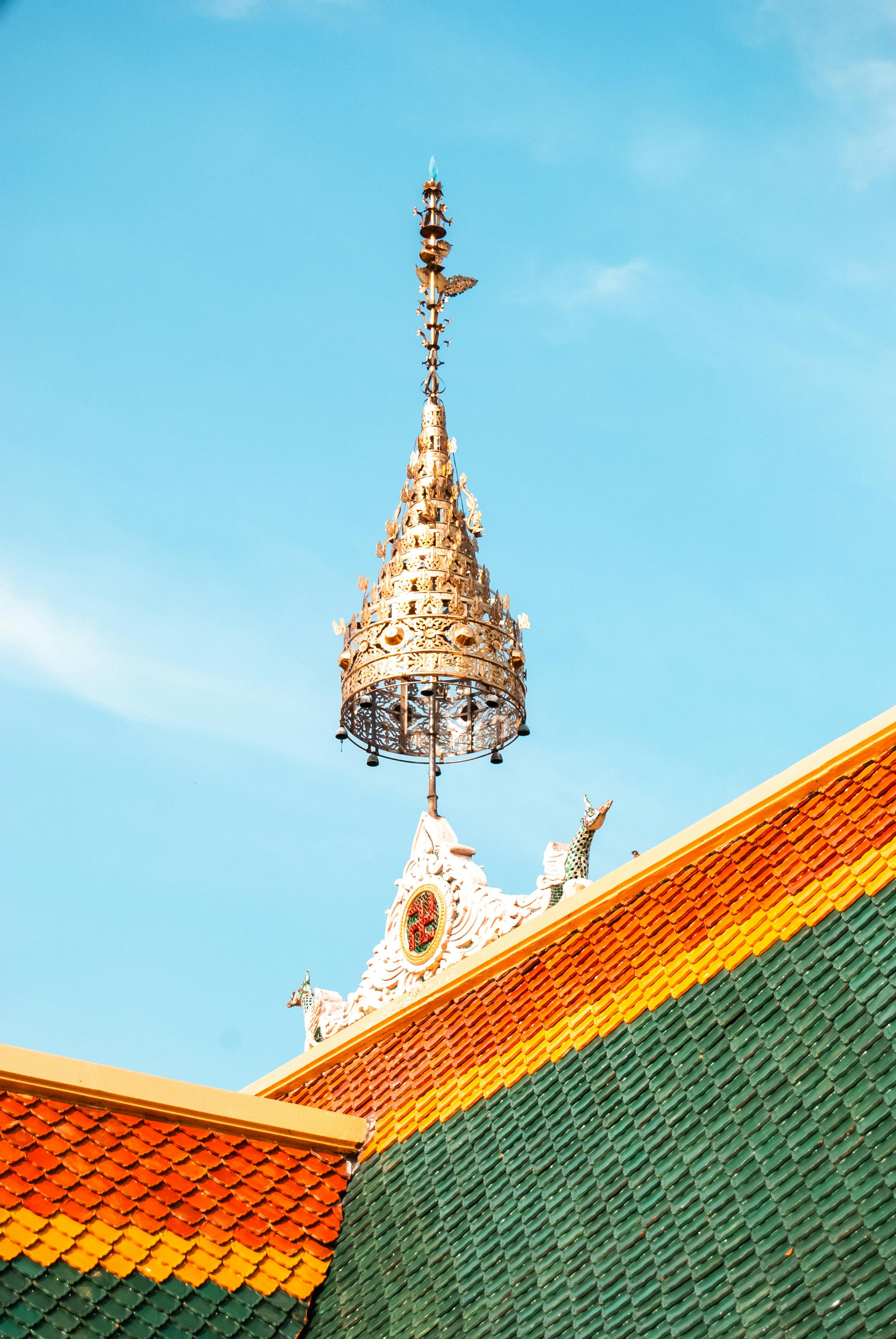 Colorful Roof and Ornate Tower Against Clear Sky · Free Stock Photo