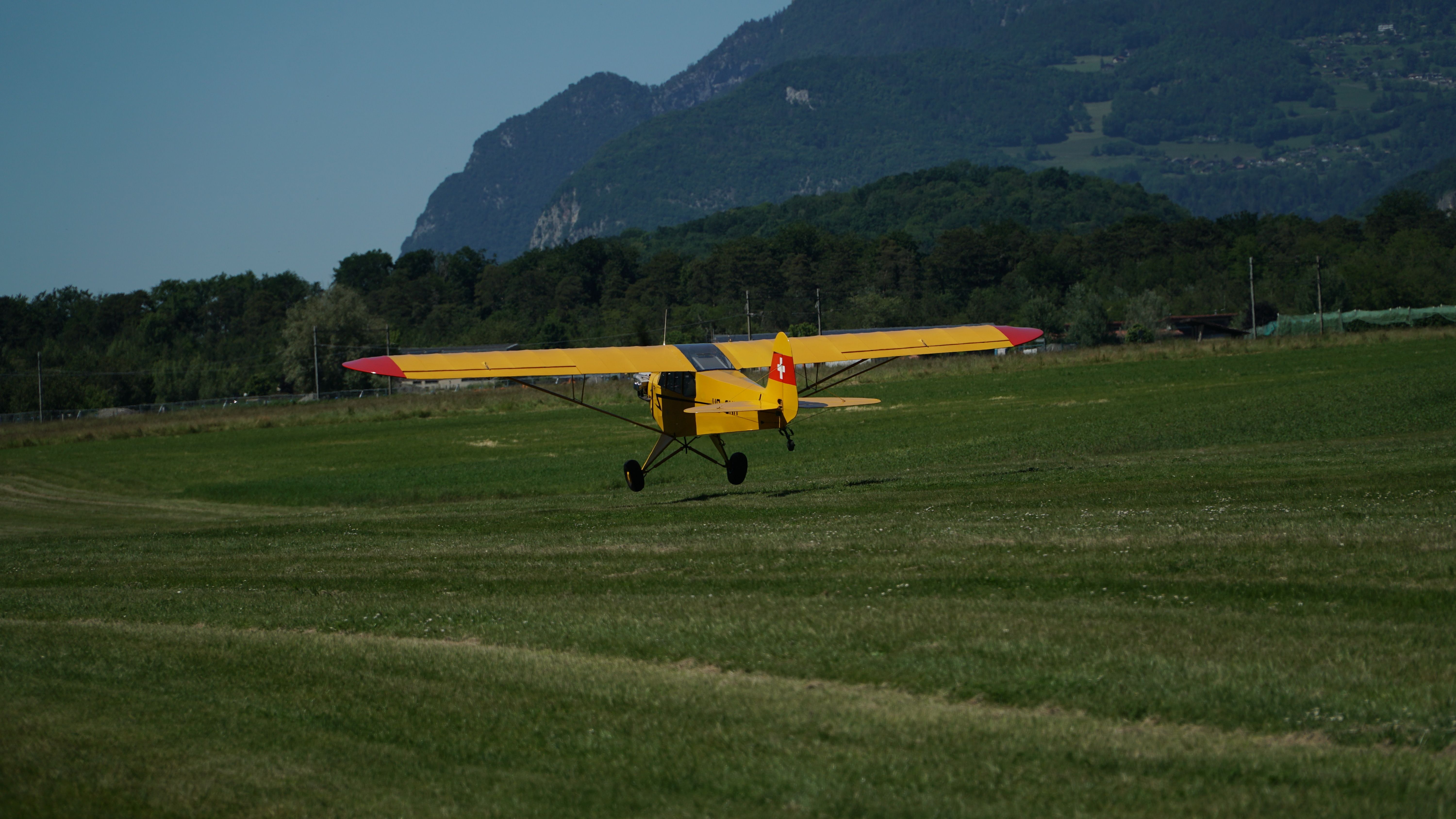 Bright Yellow Piper Aircraft in Swiss Alps · Free Stock Photo