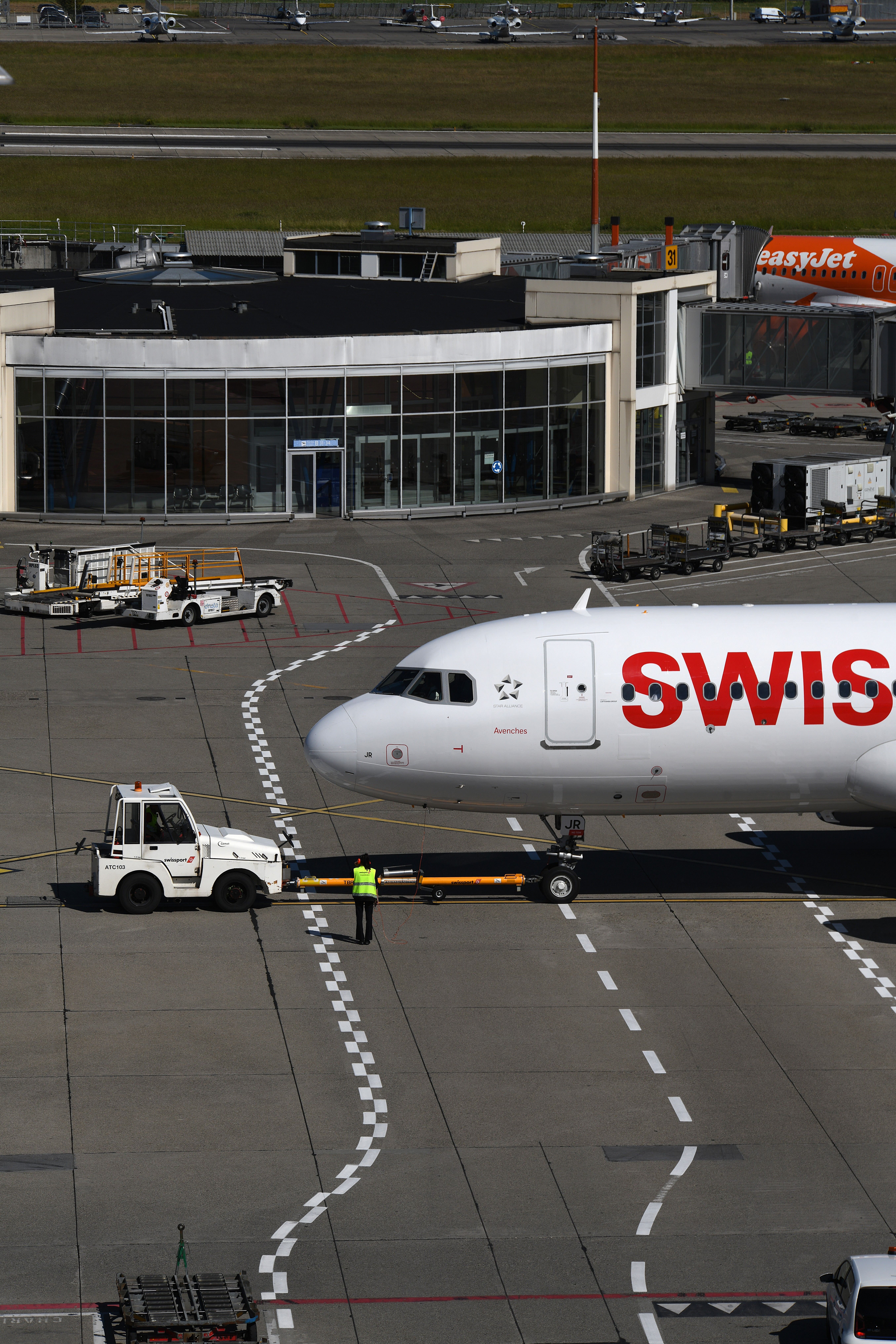 Swiss Airplane Taxiing at Genève Airport · Free Stock Photo