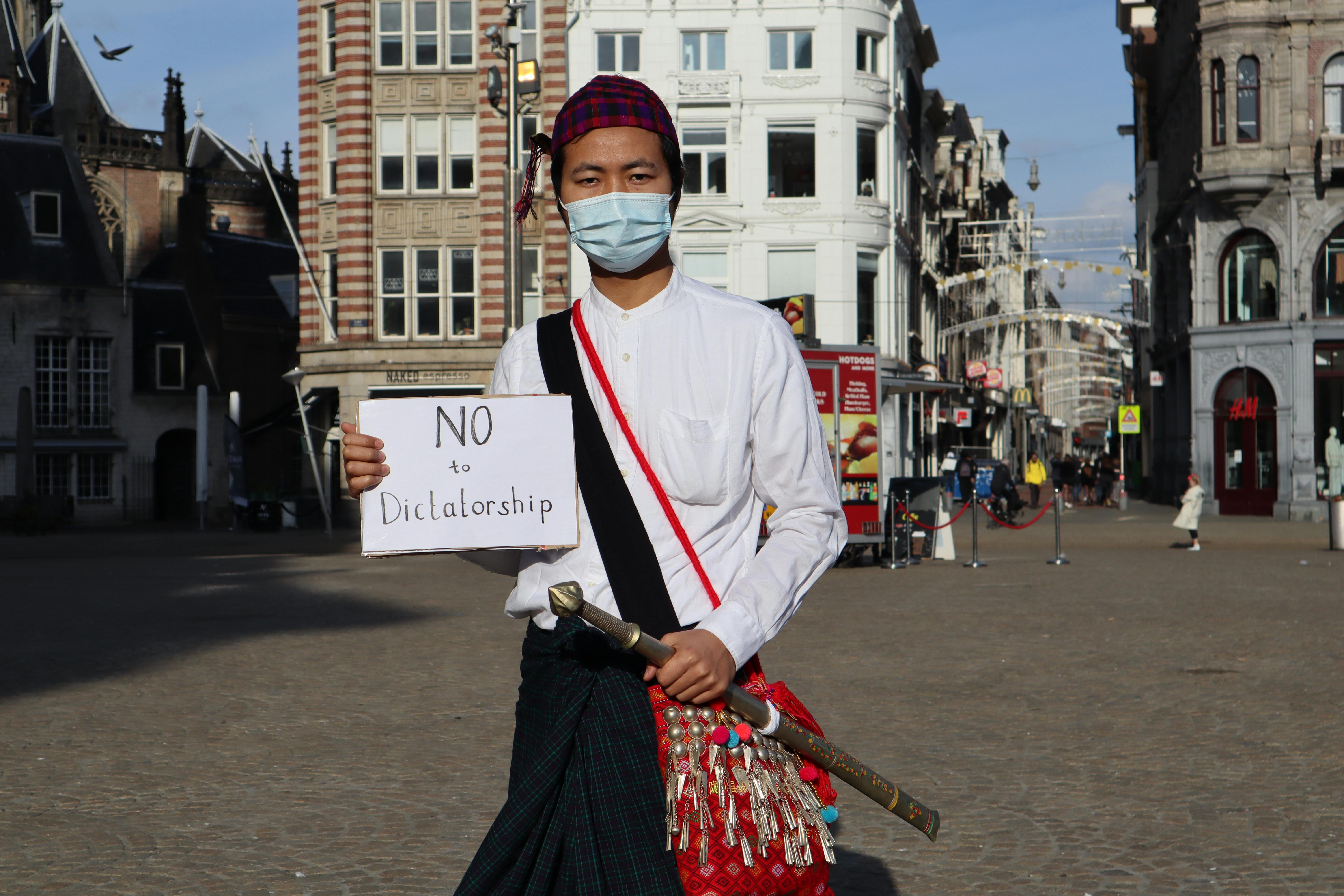 Protester Holding Sign Against Dictatorship in Urban Setting · Free ...