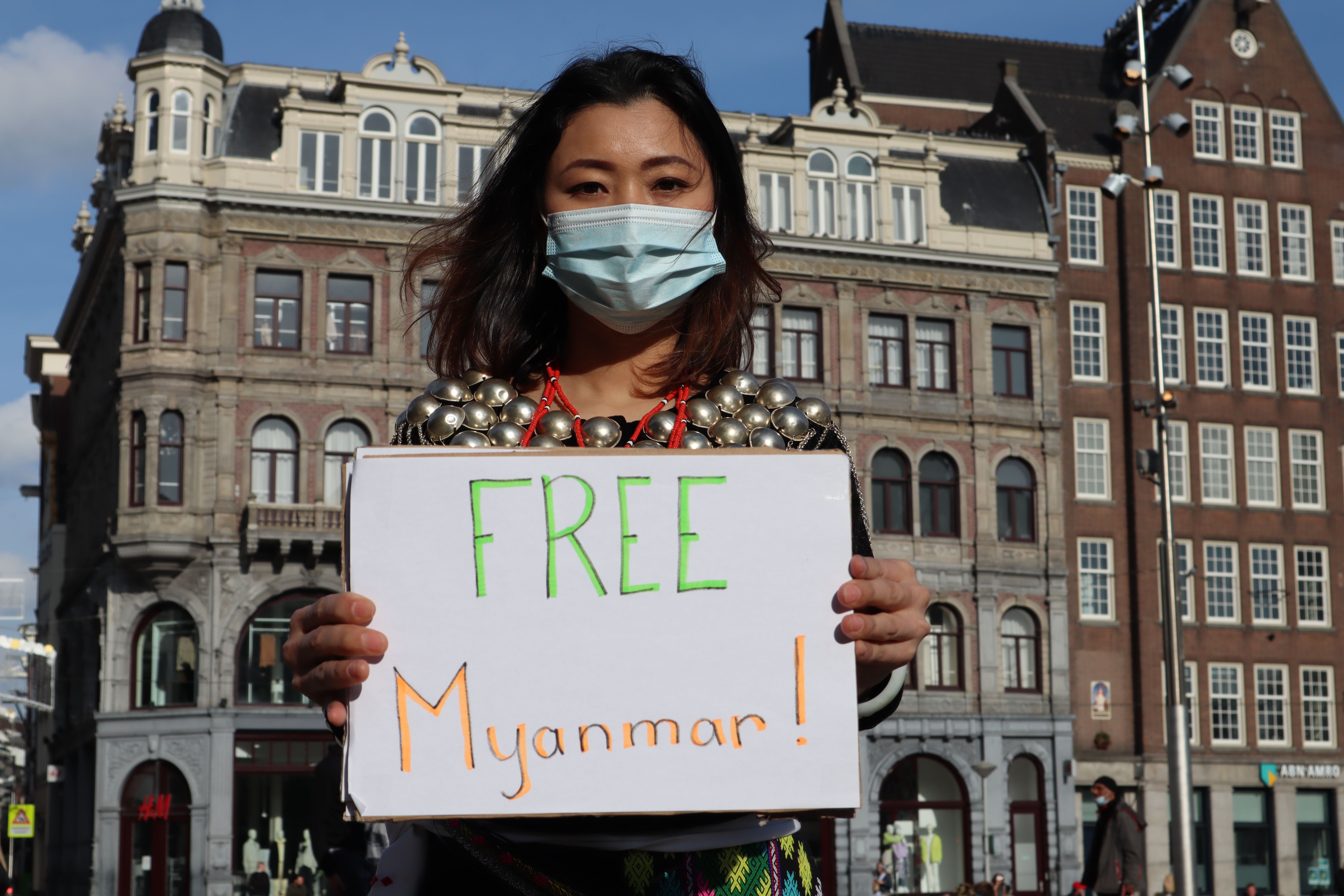 Protester With Free Myanmar Sign in Urban Setting · Free Stock Photo