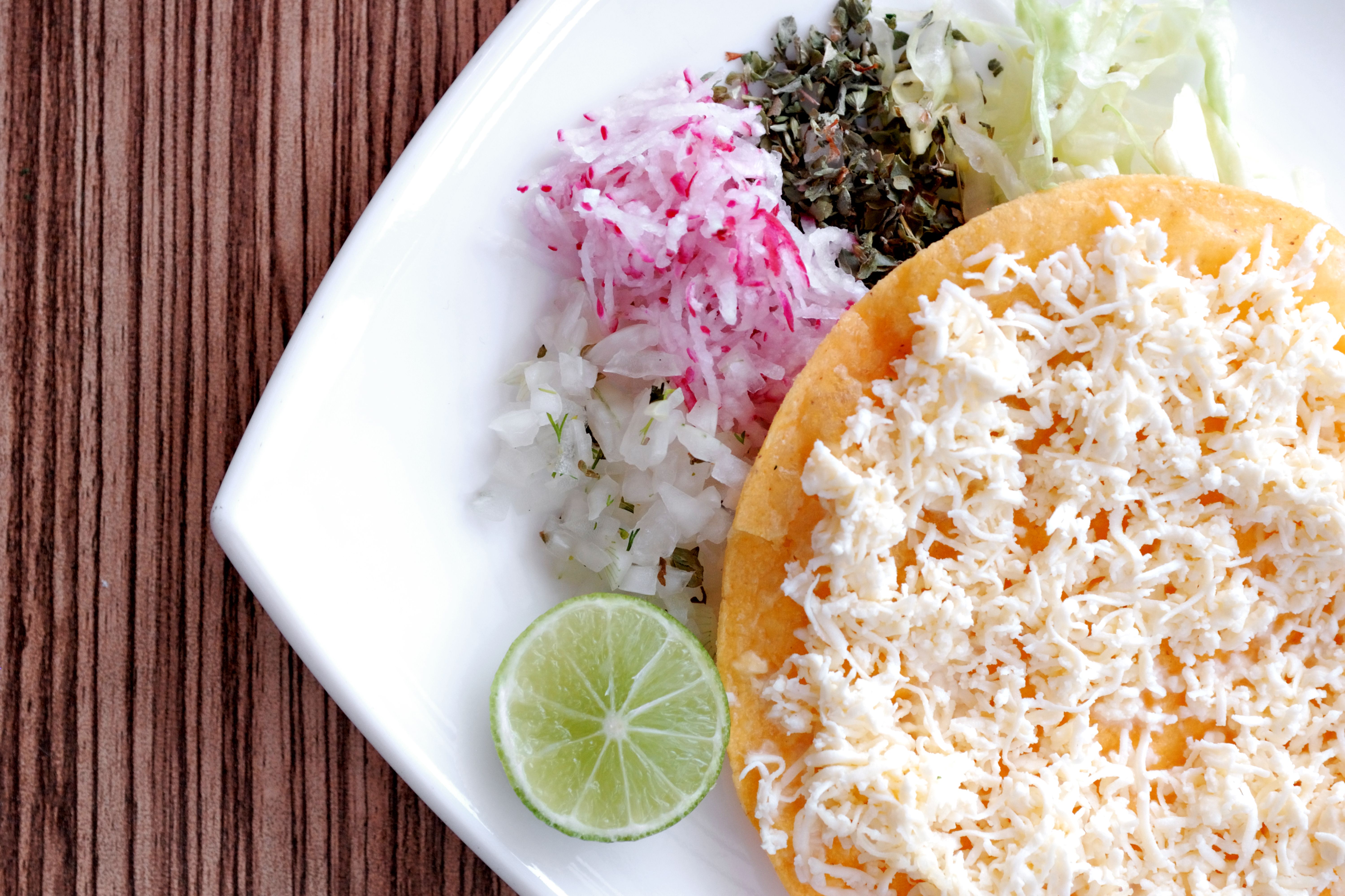 Mexican Tostada with Cheese and Fresh Toppings · Free Stock Photo
