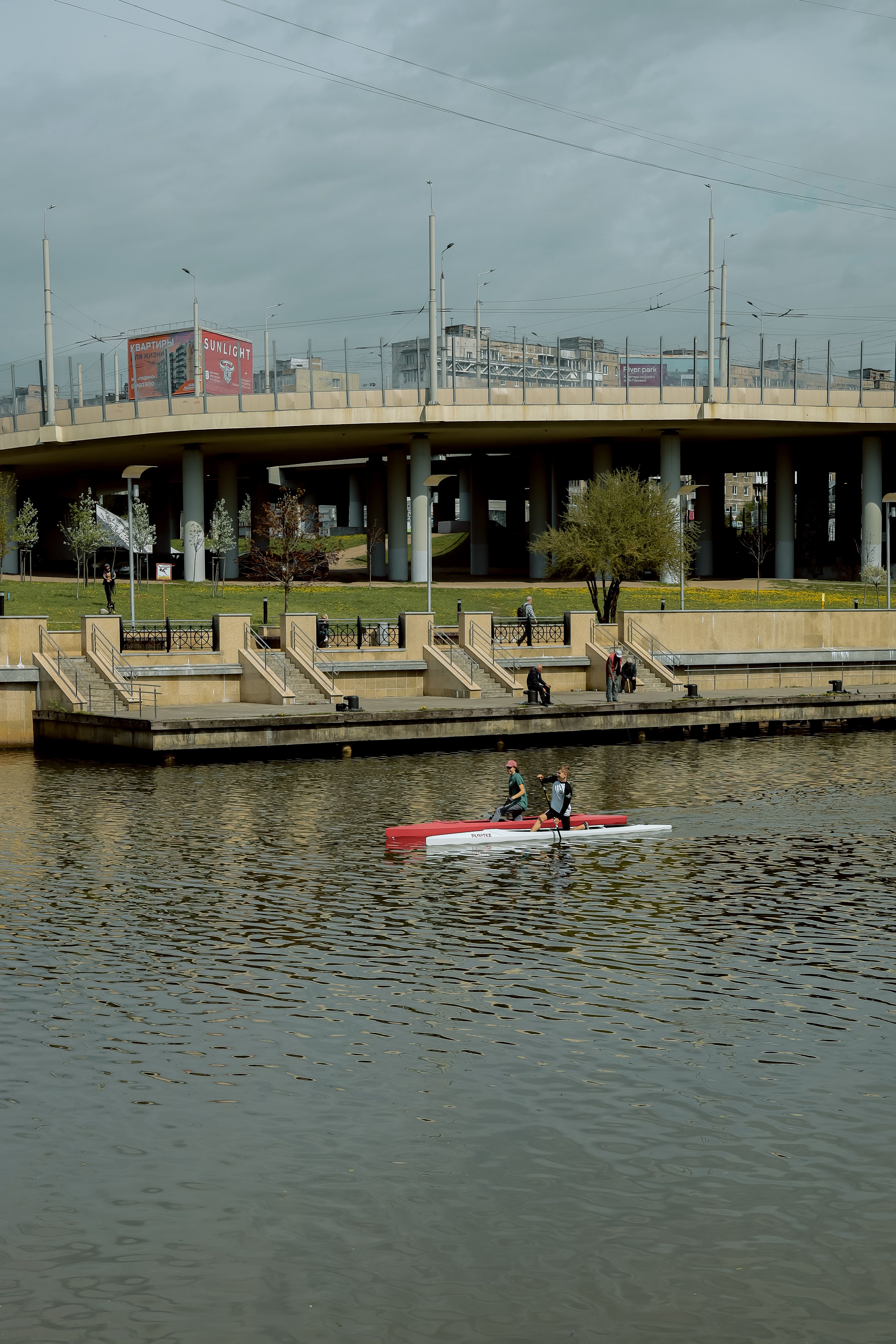 Kayakers Paddle Under Urban Overpass · Free Stock Photo
