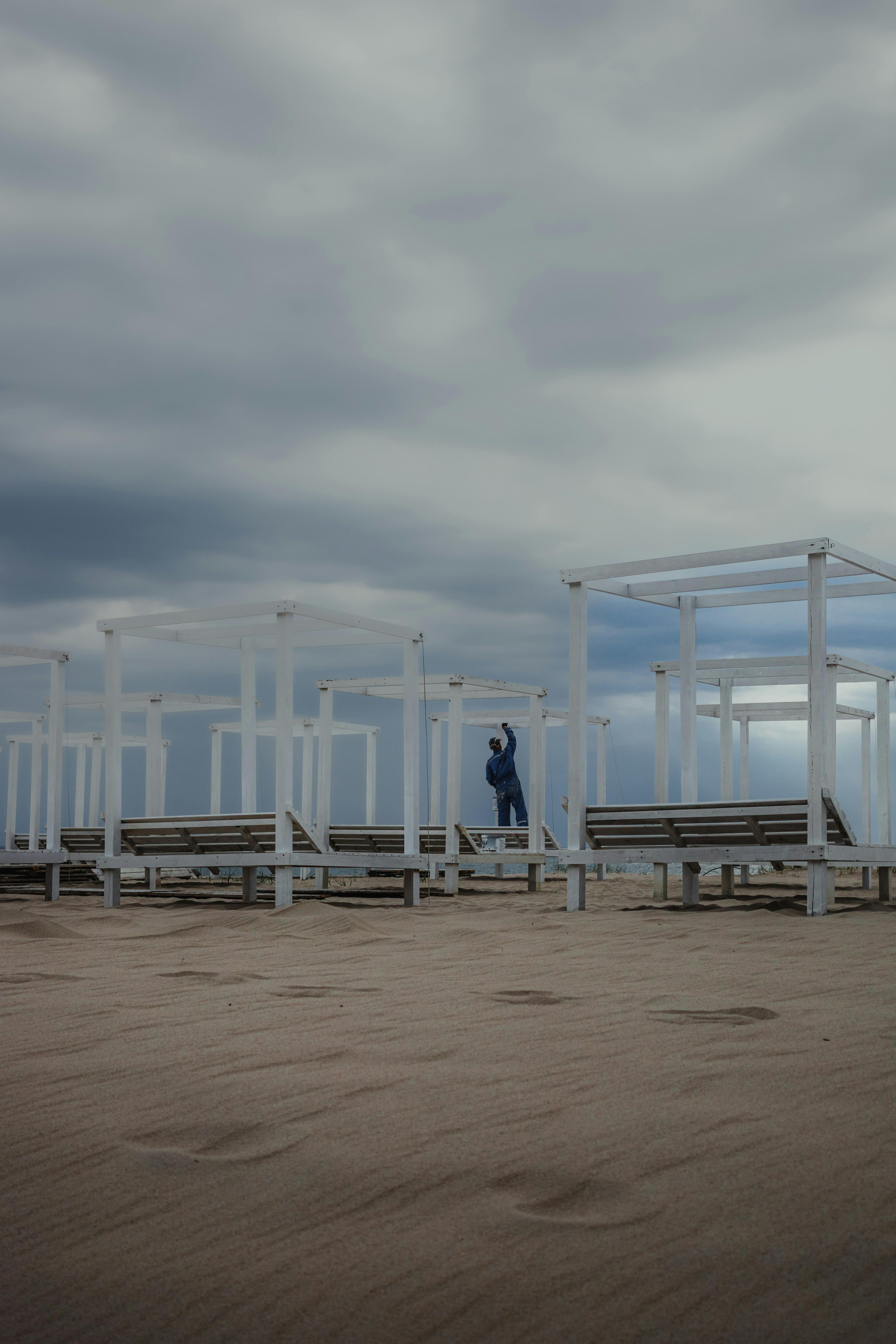 Minimalist Beach Scene with Wooden Structures · Free Stock Photo
