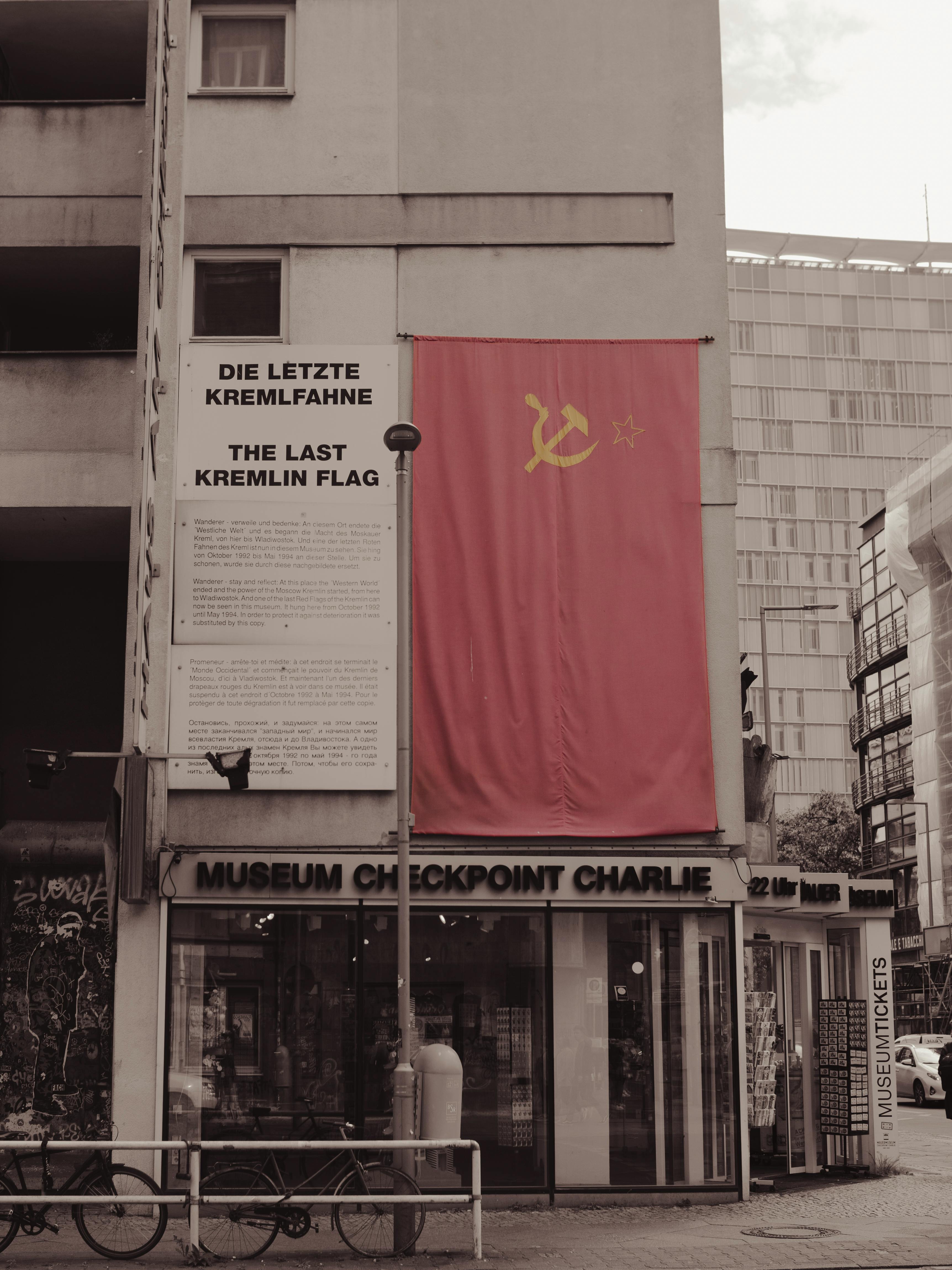 Historic Checkpoint Charlie with Soviet Flag Display · Free Stock Photo
