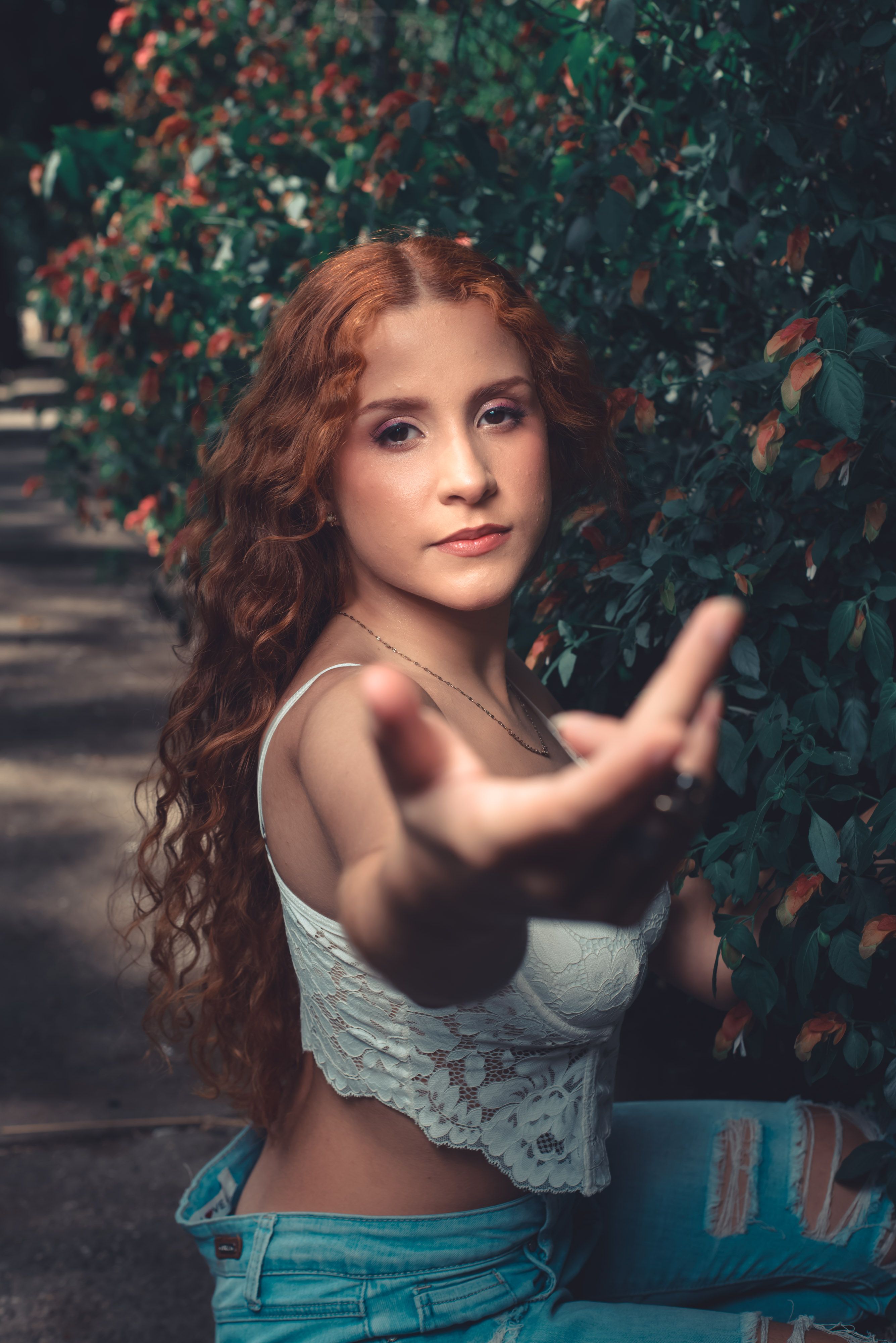 Young Woman Reaching Out in Outdoor Portrait · Free Stock Photo