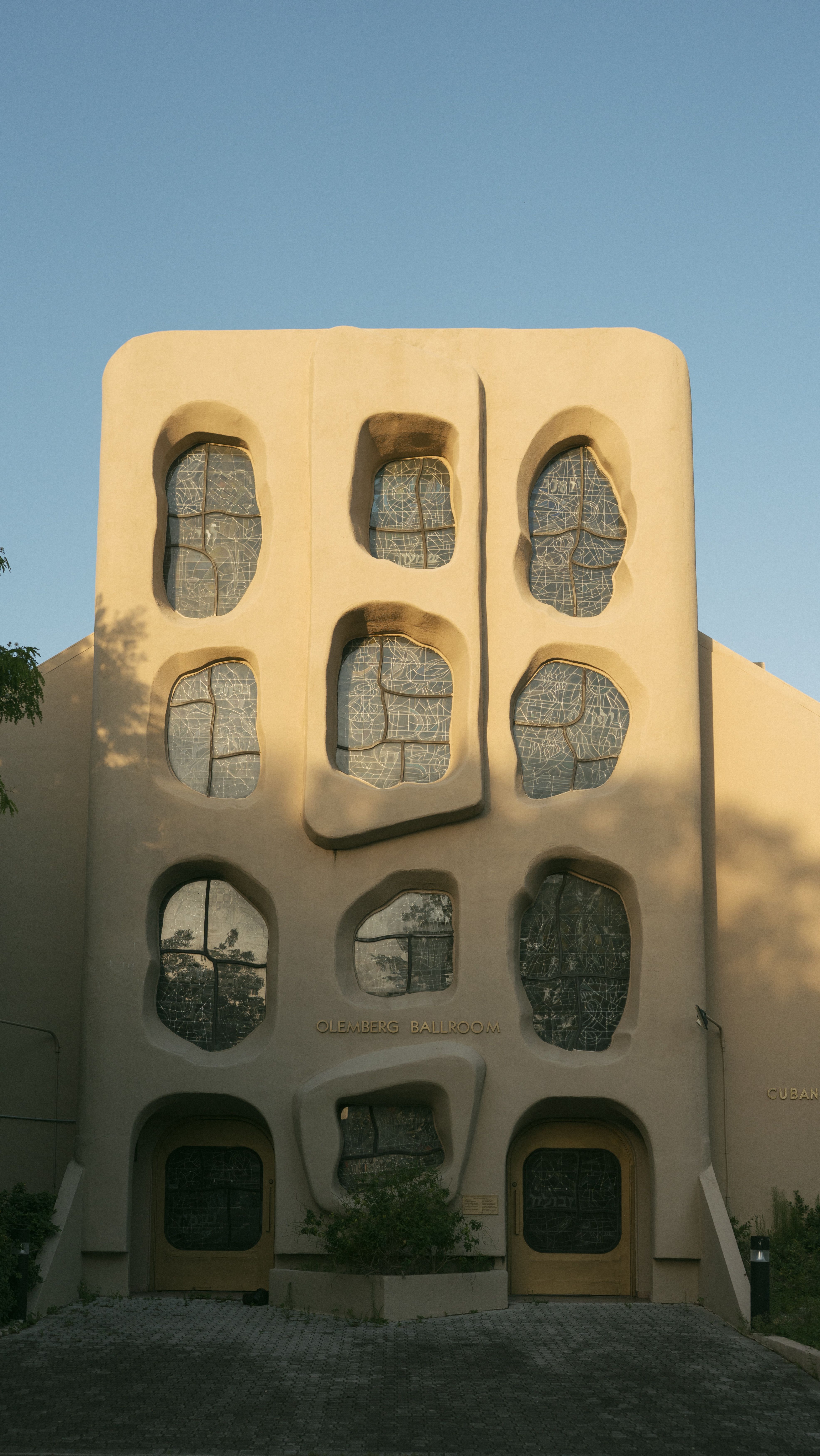 Unique Architectural Facade with Organic Window Shapes · Free Stock Photo