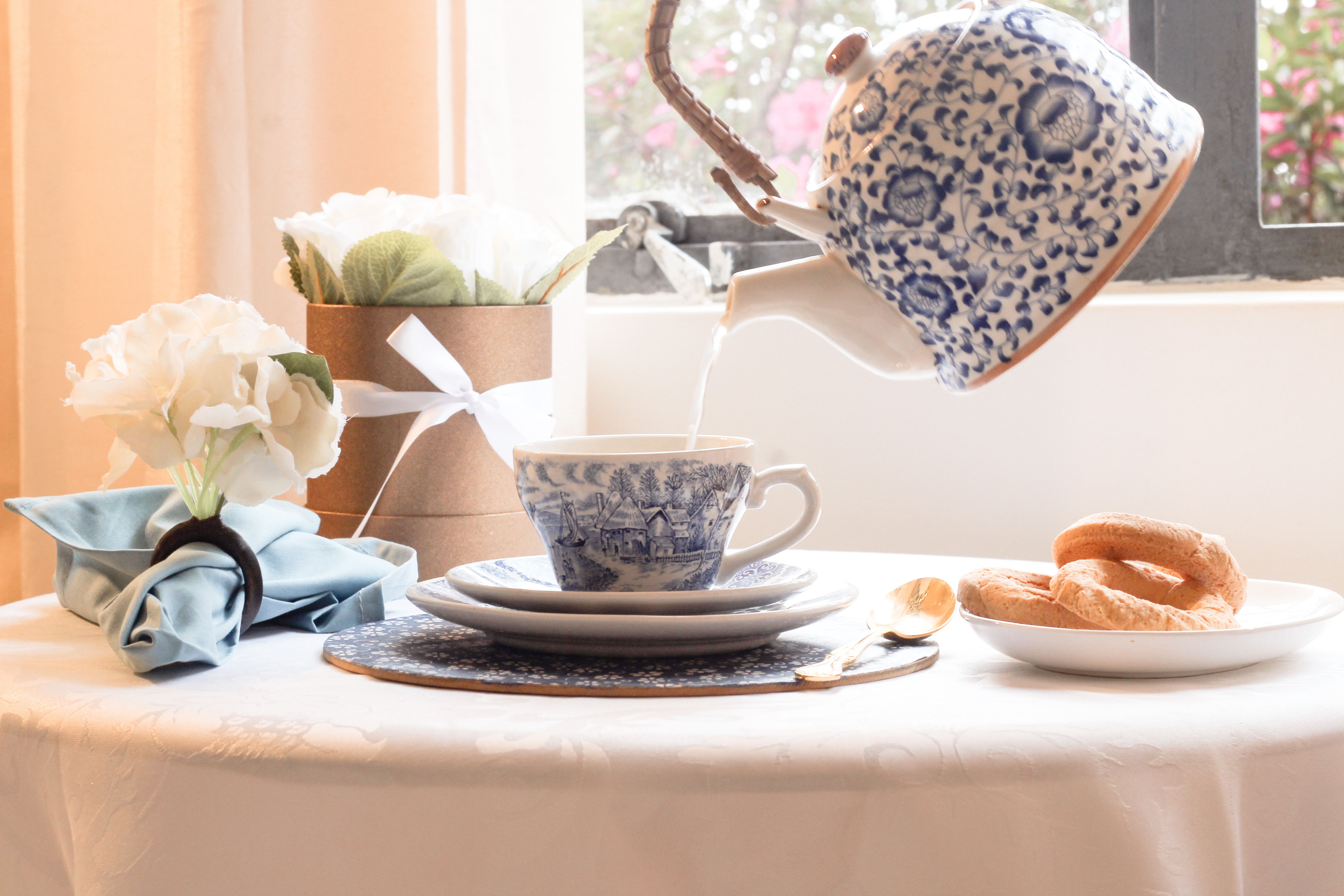 Elegant Tea Setting with Flowers and Pastries · Free Stock Photo