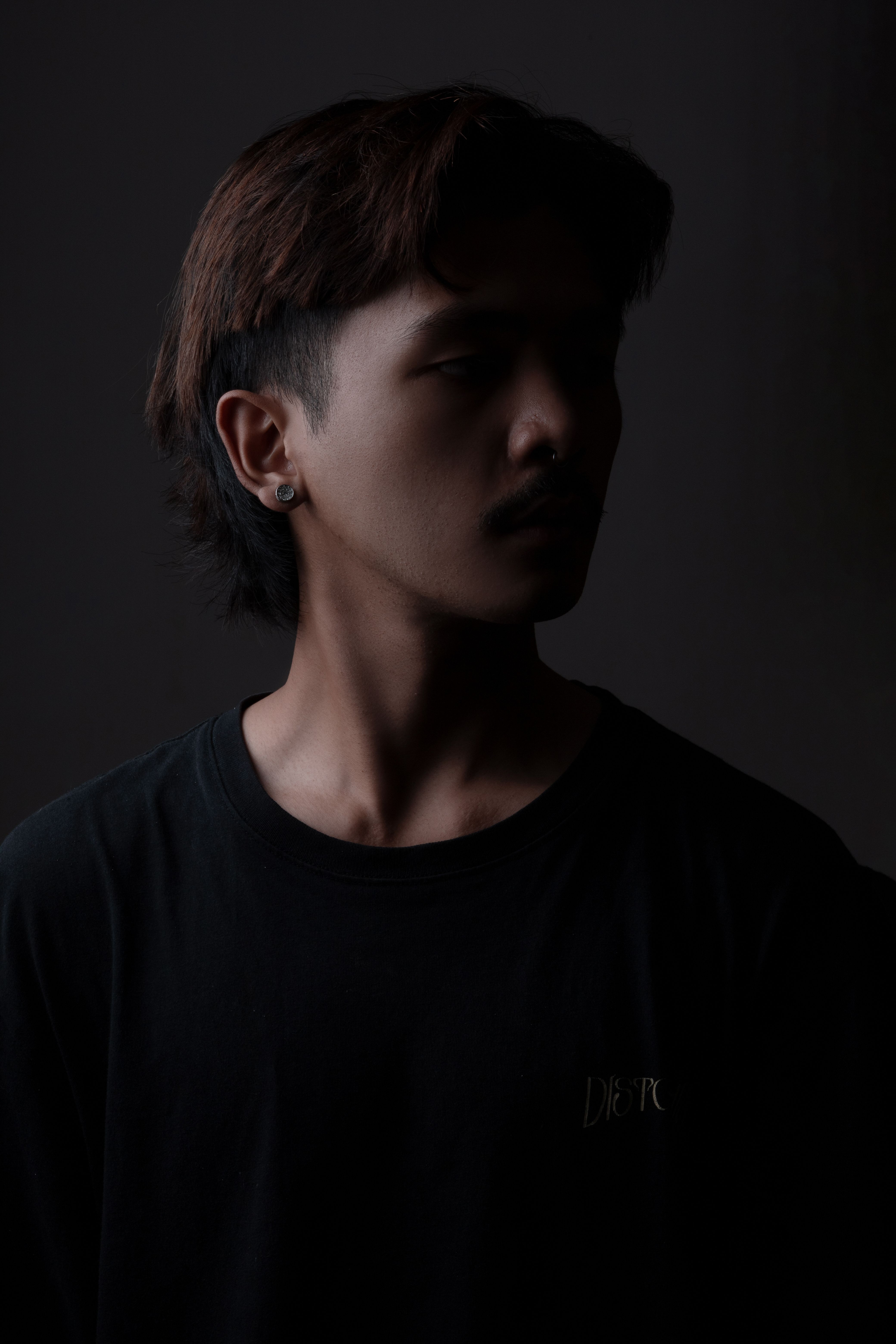 Moody Portrait of a Young Man in Low Light · Free Stock Photo